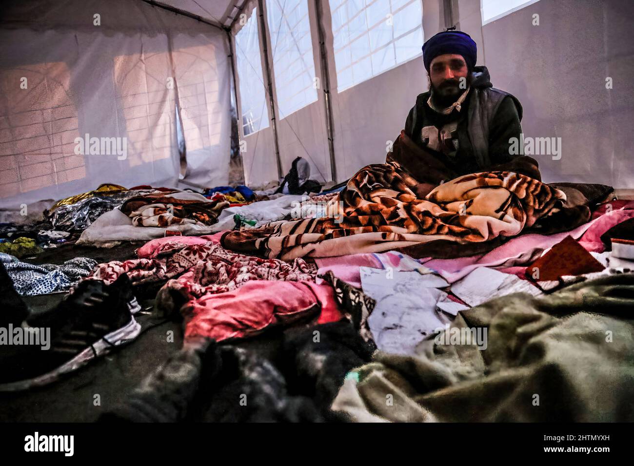 A man from India rests after arriving at the Polish border. Thousands ...