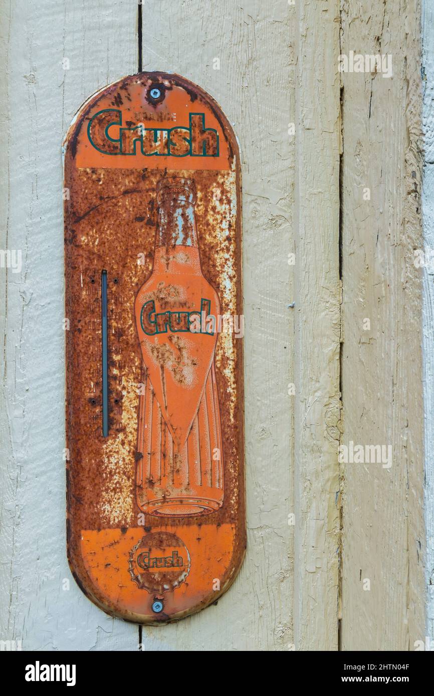 Antique rusted metal Orange Crush thermometer on outside wall of old ...