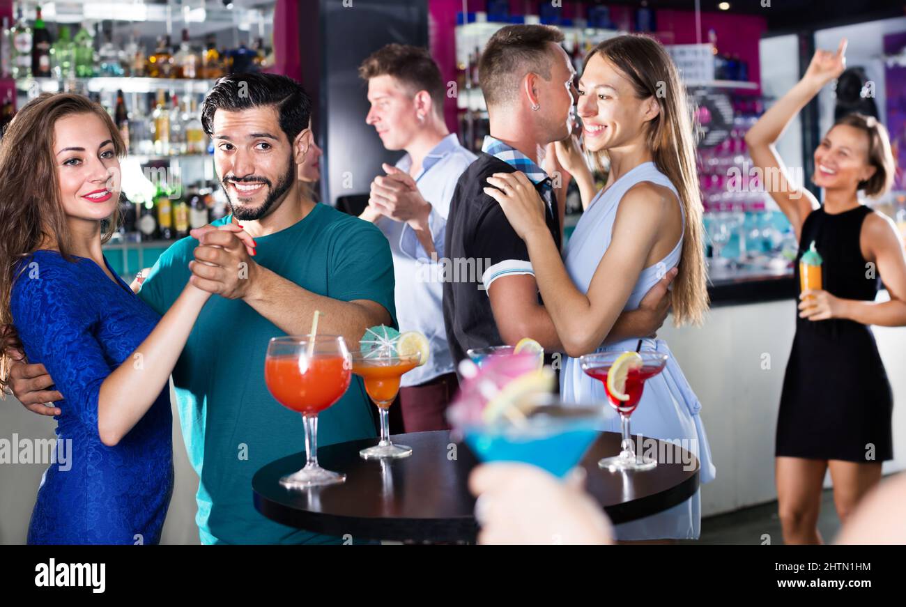 Female with man are dancing in bar Stock Photo - Alamy