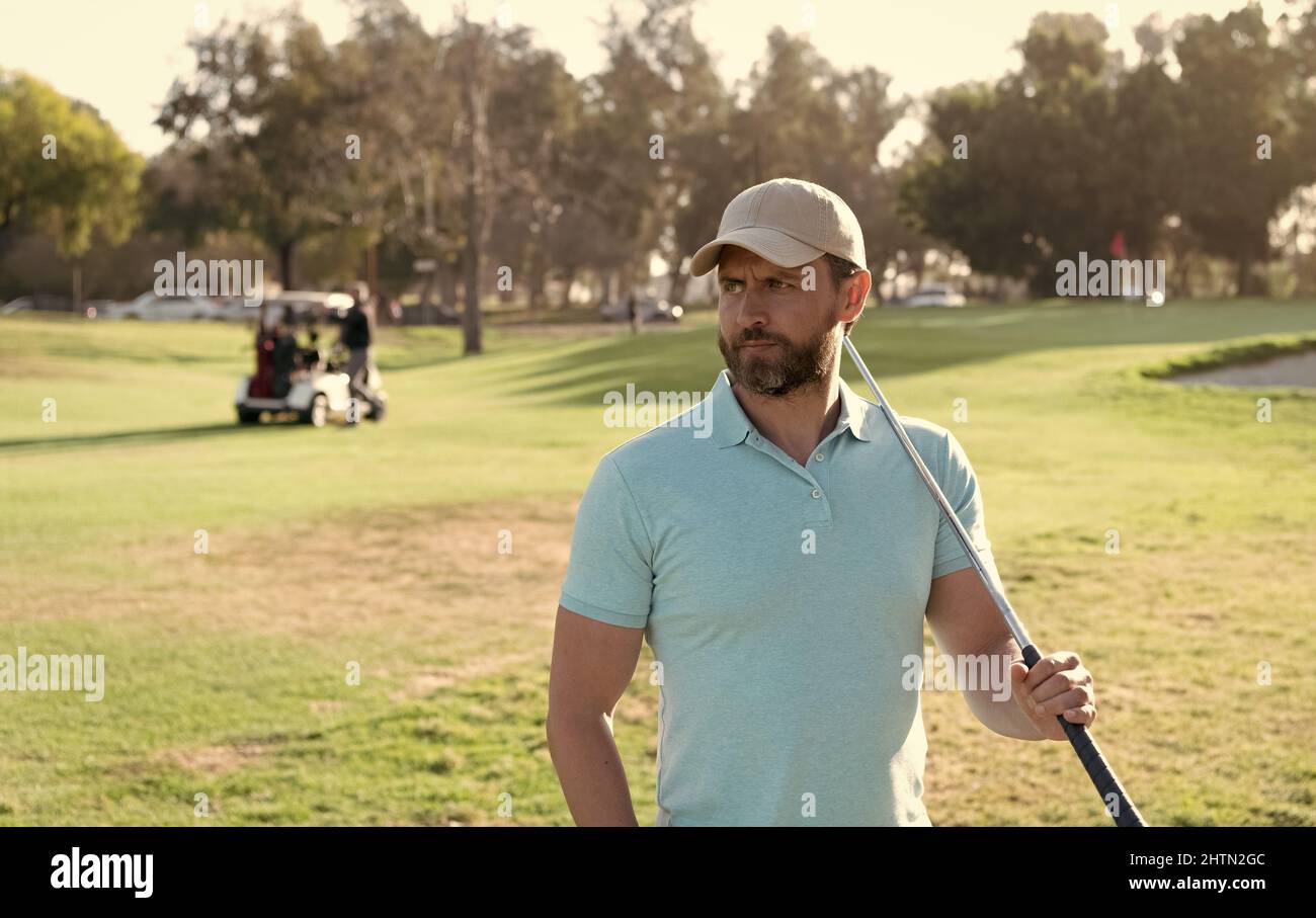 portrait of golfer in cap with golf club looking away. people lifestyle ...