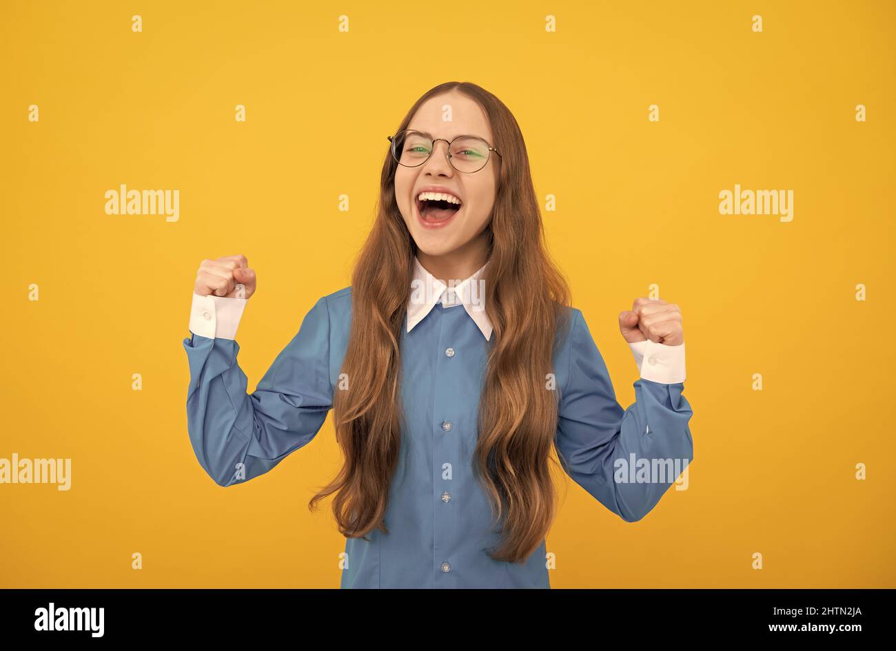 Happy back to school child show winning gesture yellow background ...
