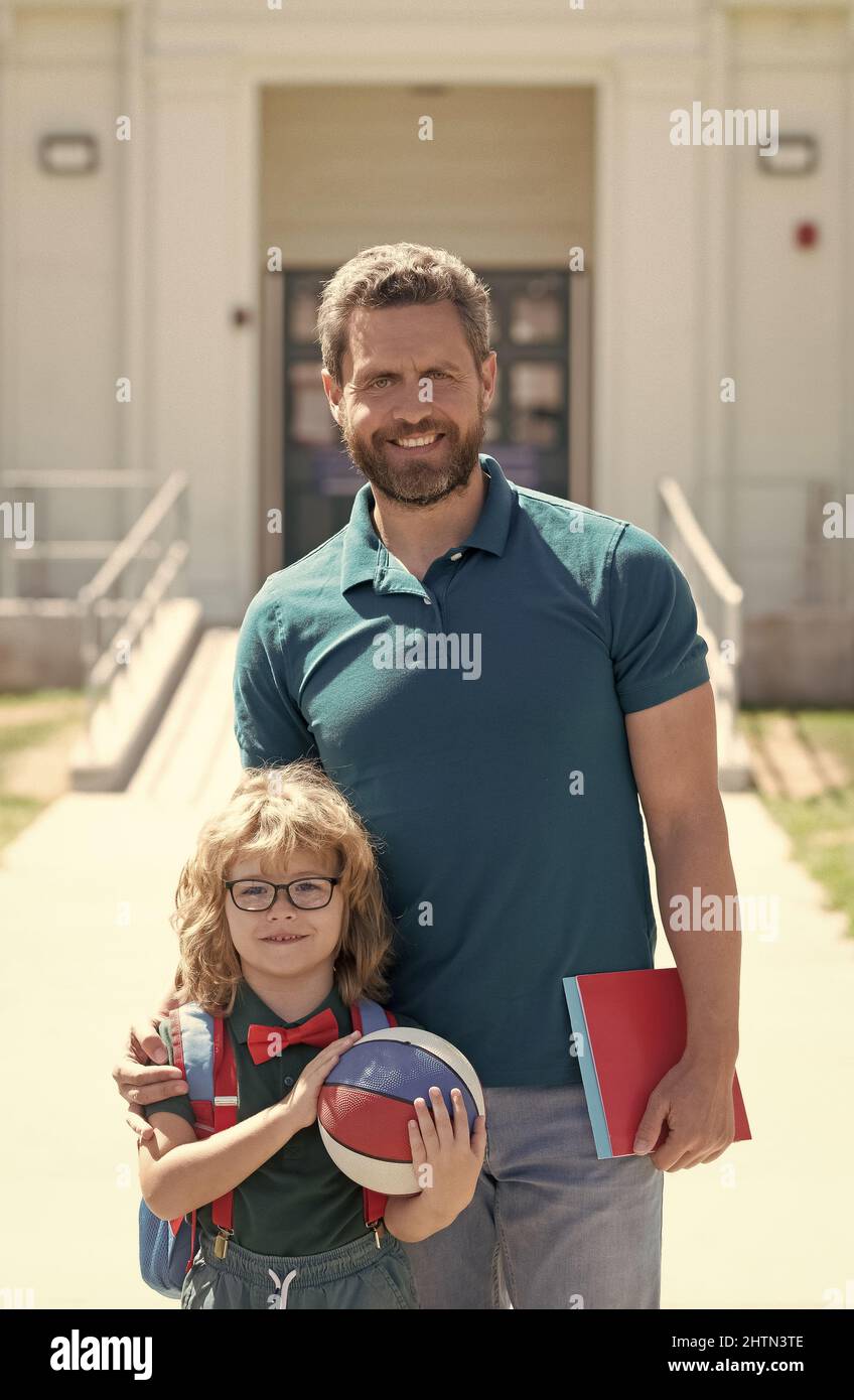 happy father with nerd son in glasses coming back from first day at ...
