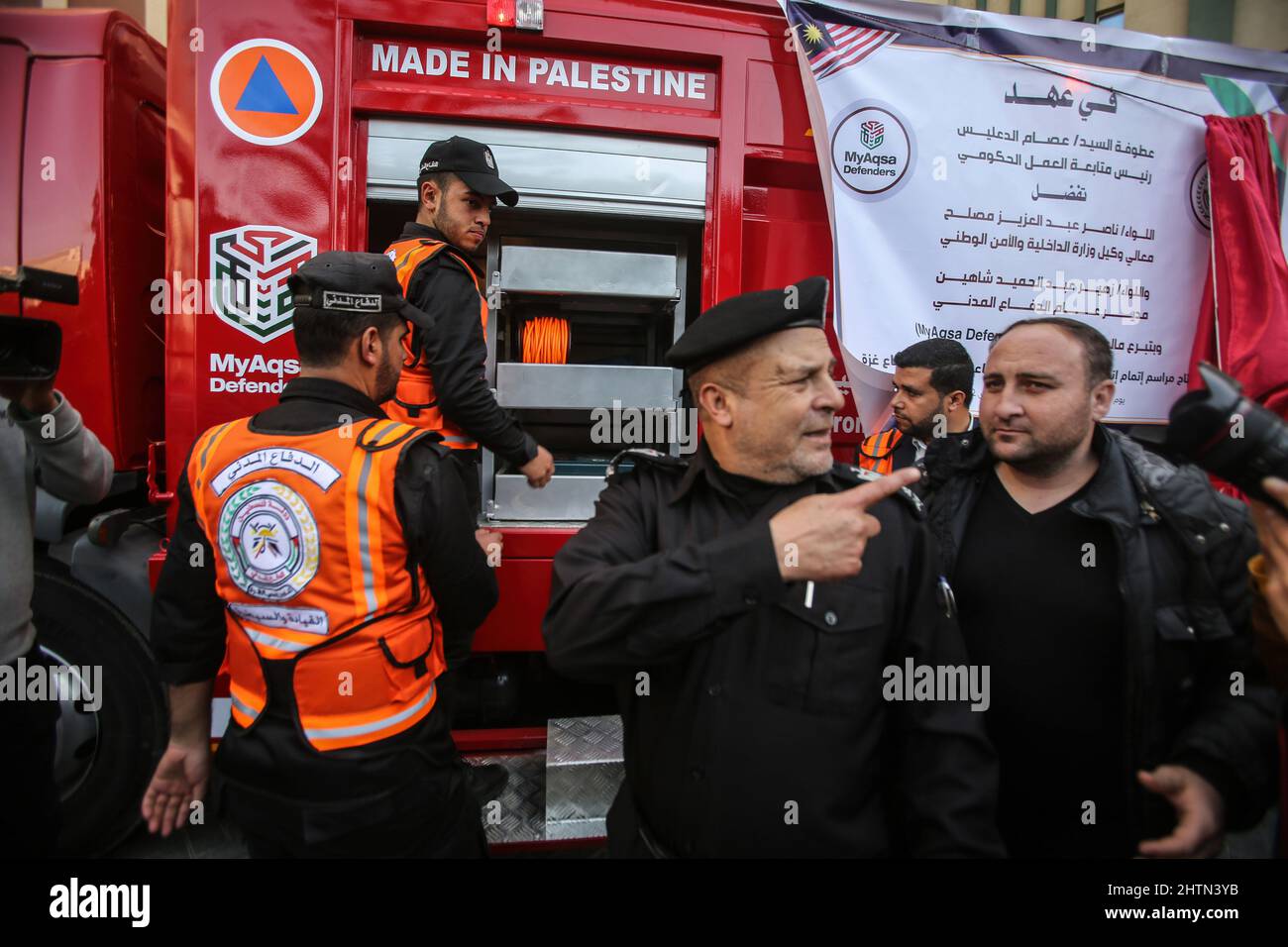 A member of Palestinian Civil defence loyal to Hamas stands near ...