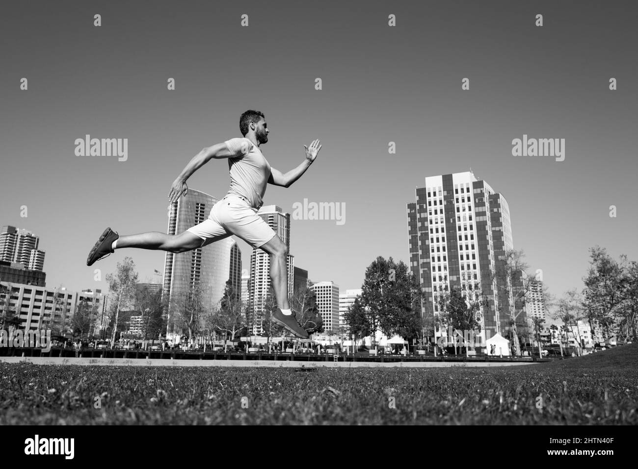 Sporty man runner running in summer. Dynamic jumping movement Stock ...