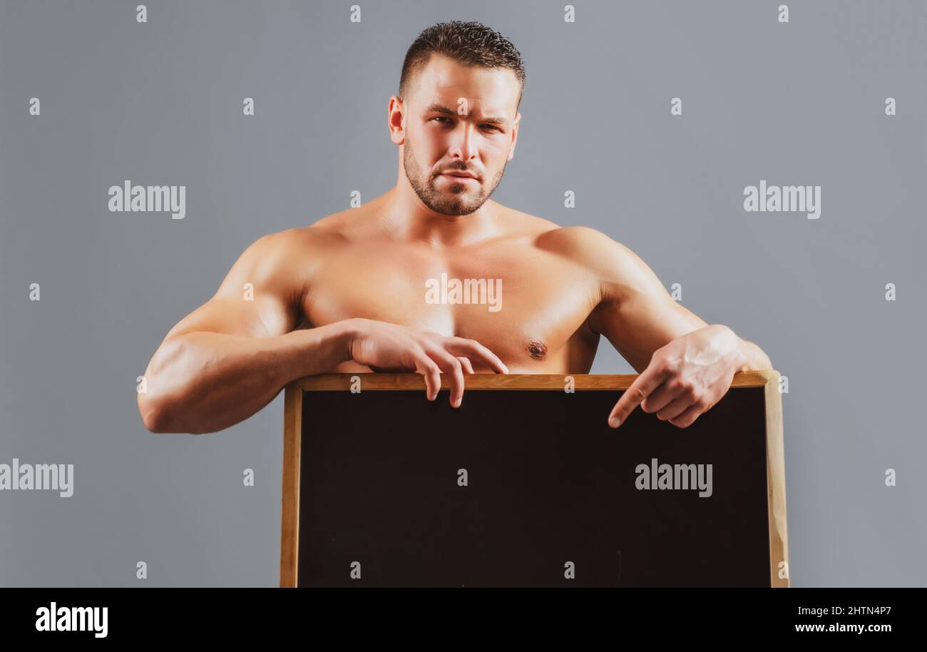 Advertising concept. Fitness man with sign board. Strong bodybuilder ...