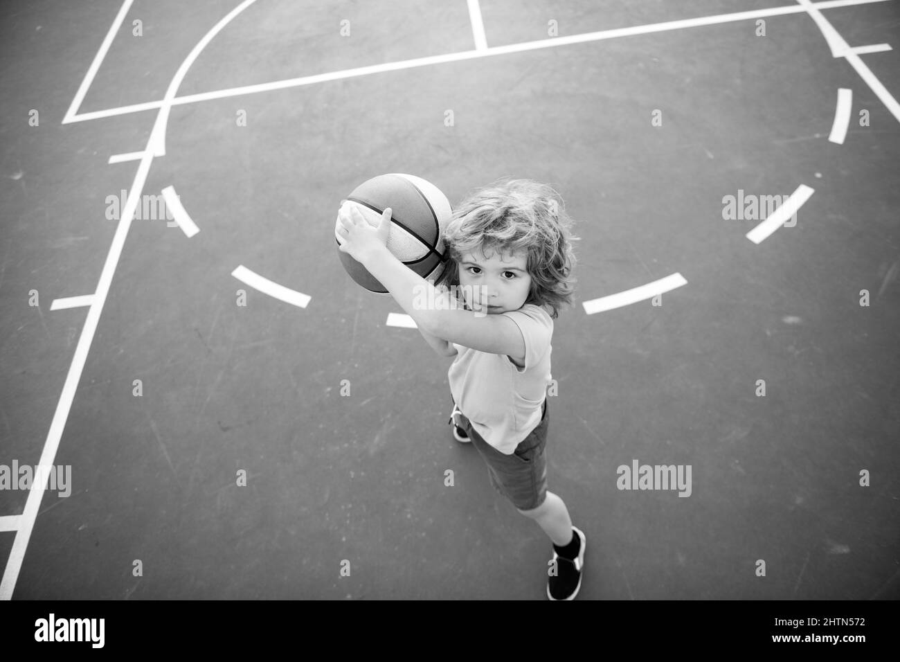 Kid boy concentrated on playing basketball. Basketball kids school ...