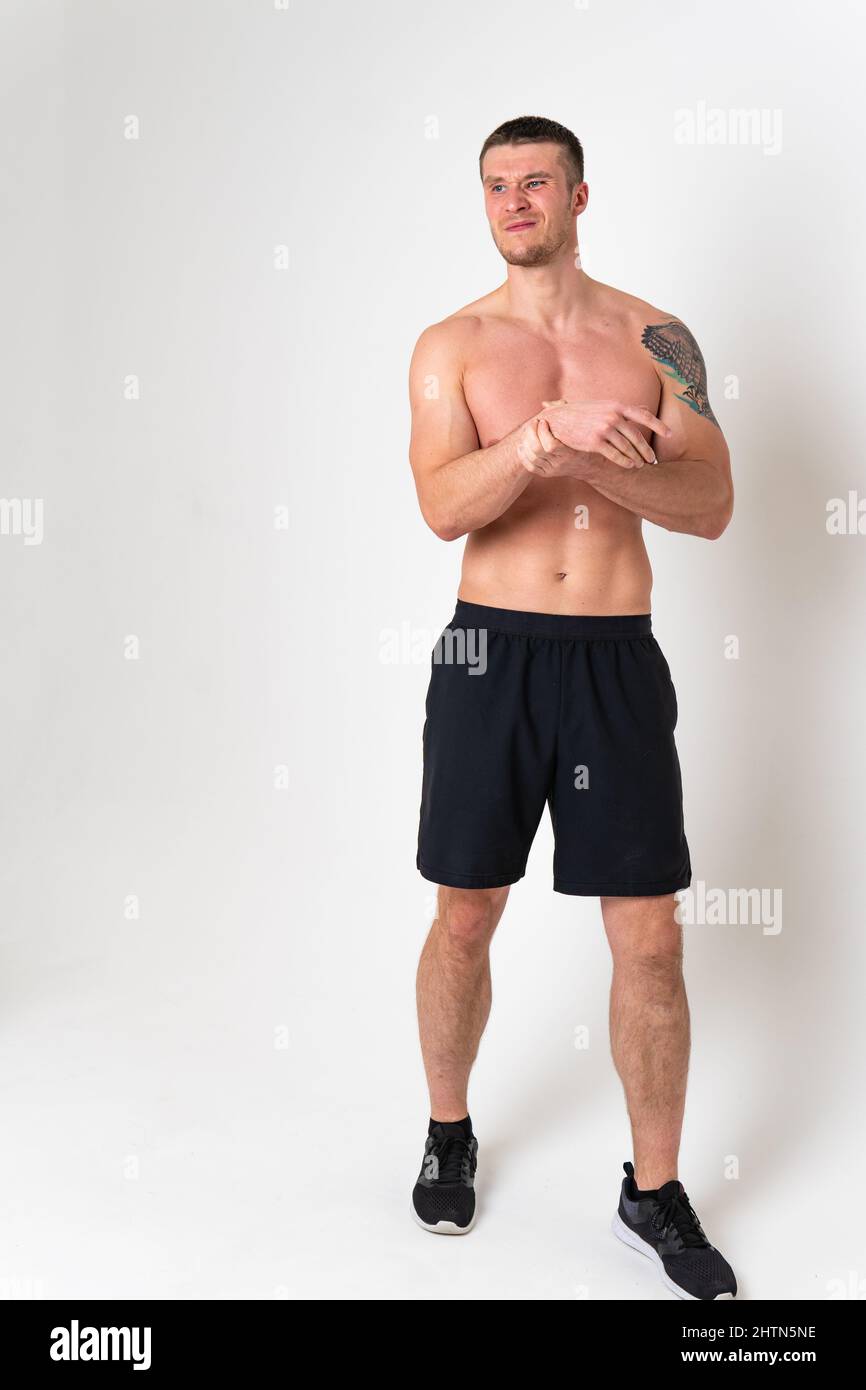 Muscles on the arm ache in a man on a white background back body injury ...