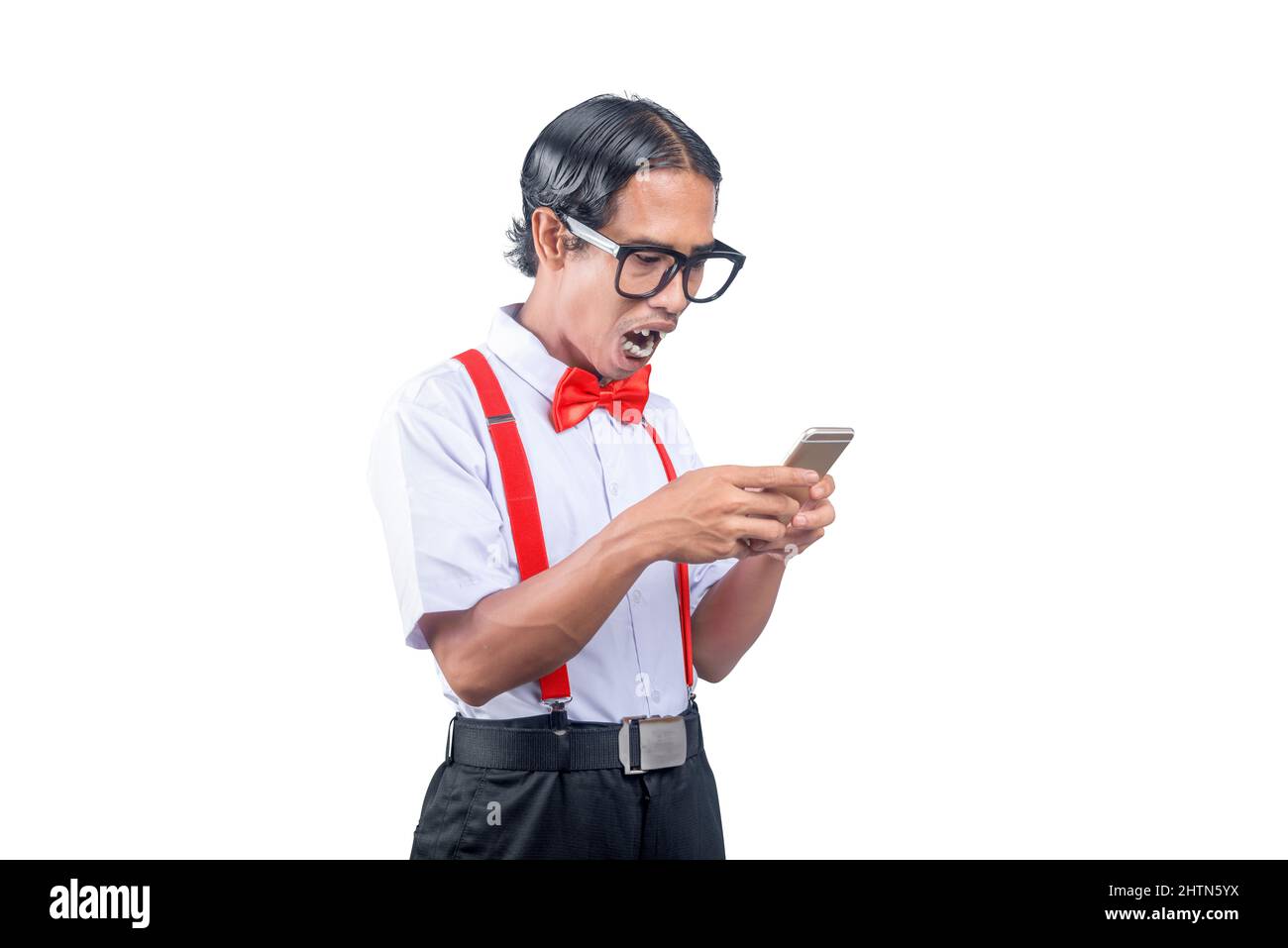 Asian nerd with an ugly face holding mobile phone with shocked ...