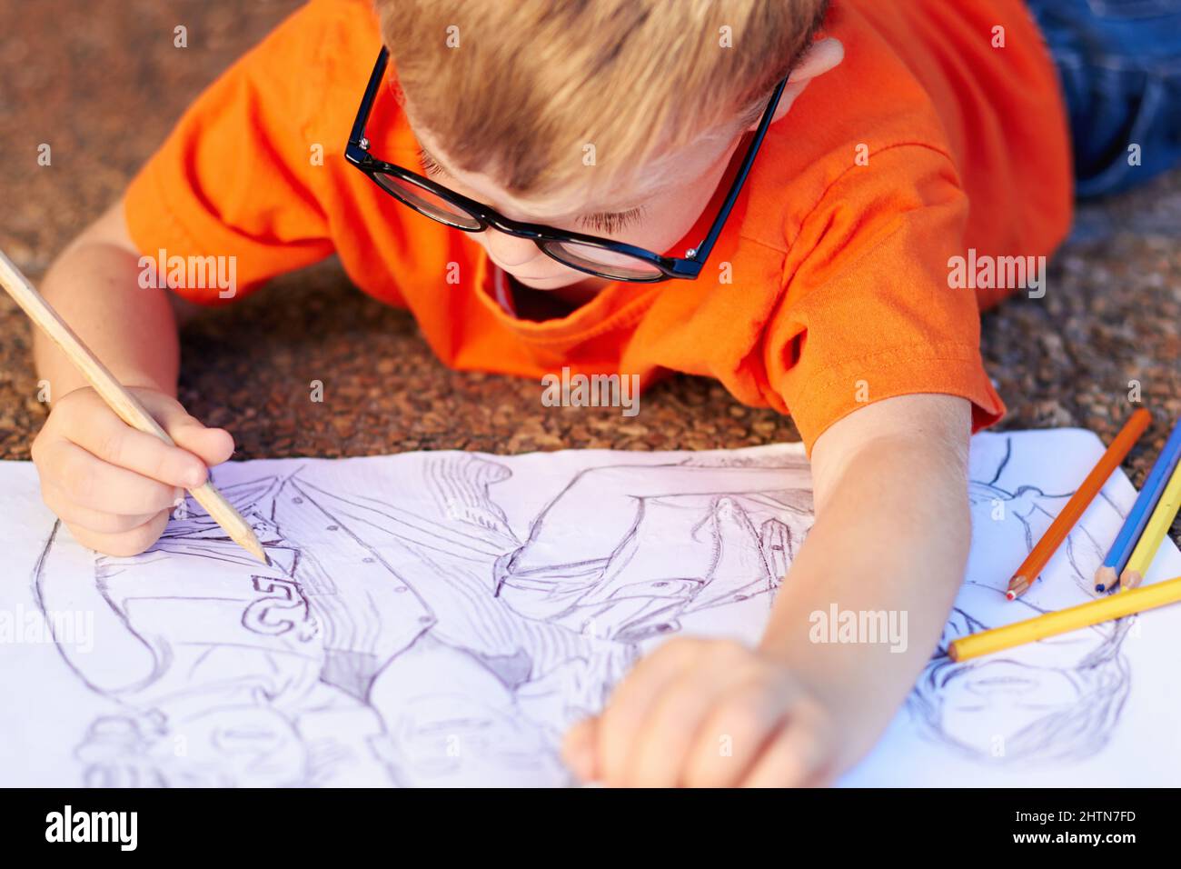 Almost done. Talented little boy drawing an incredibly advanced sketch ...