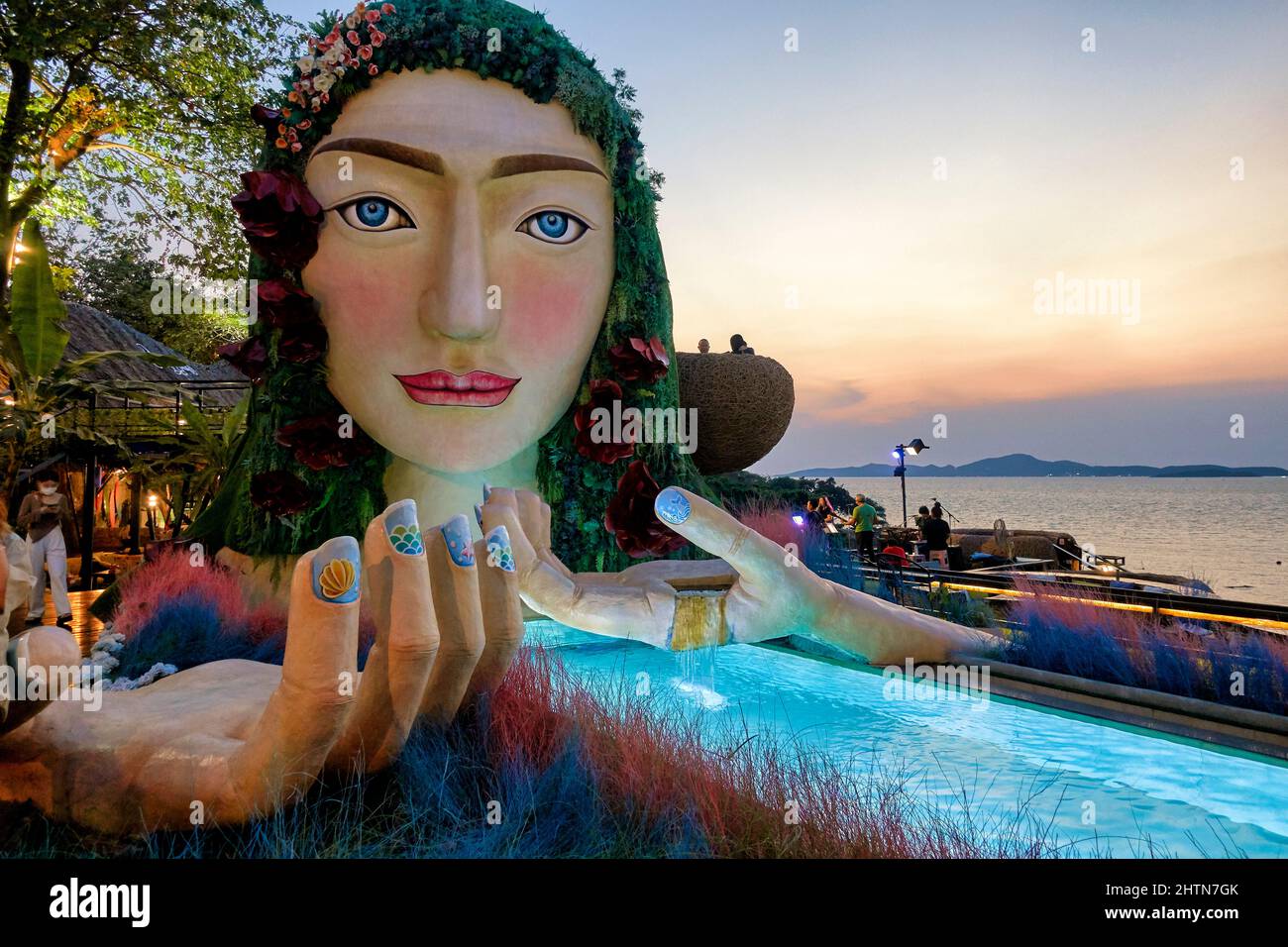 Mermaid figure feature of a large female head against a sunset ...