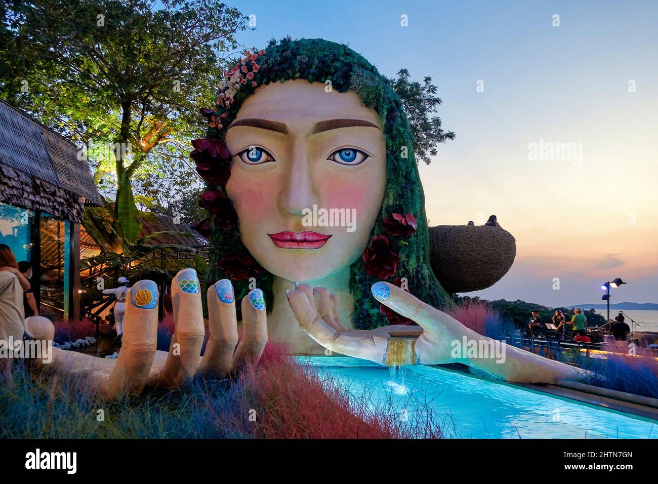 Mermaid figure feature of a large female head against a sunset ...