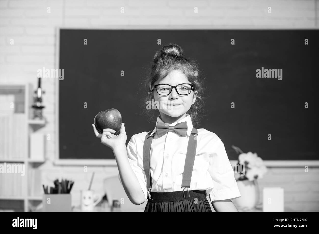 Cute child at school. Kid is learning in class on background of ...