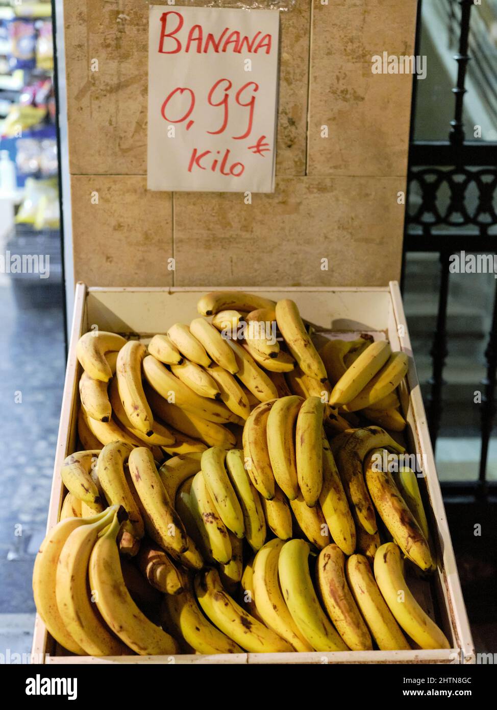 wooden box full of bananas with a paper with the price written on it ...