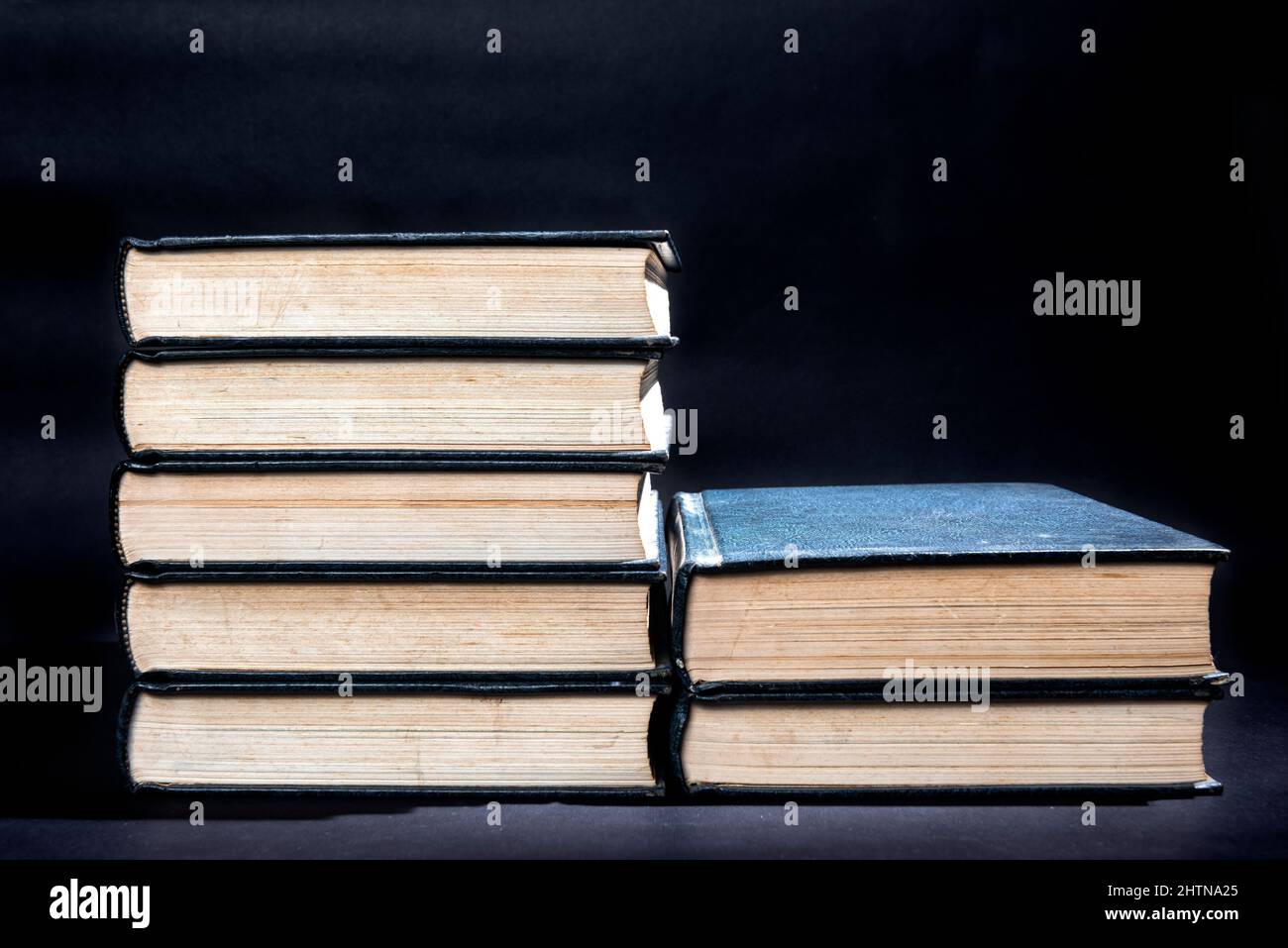 Stack of books with dark background Stock Photo - Alamy