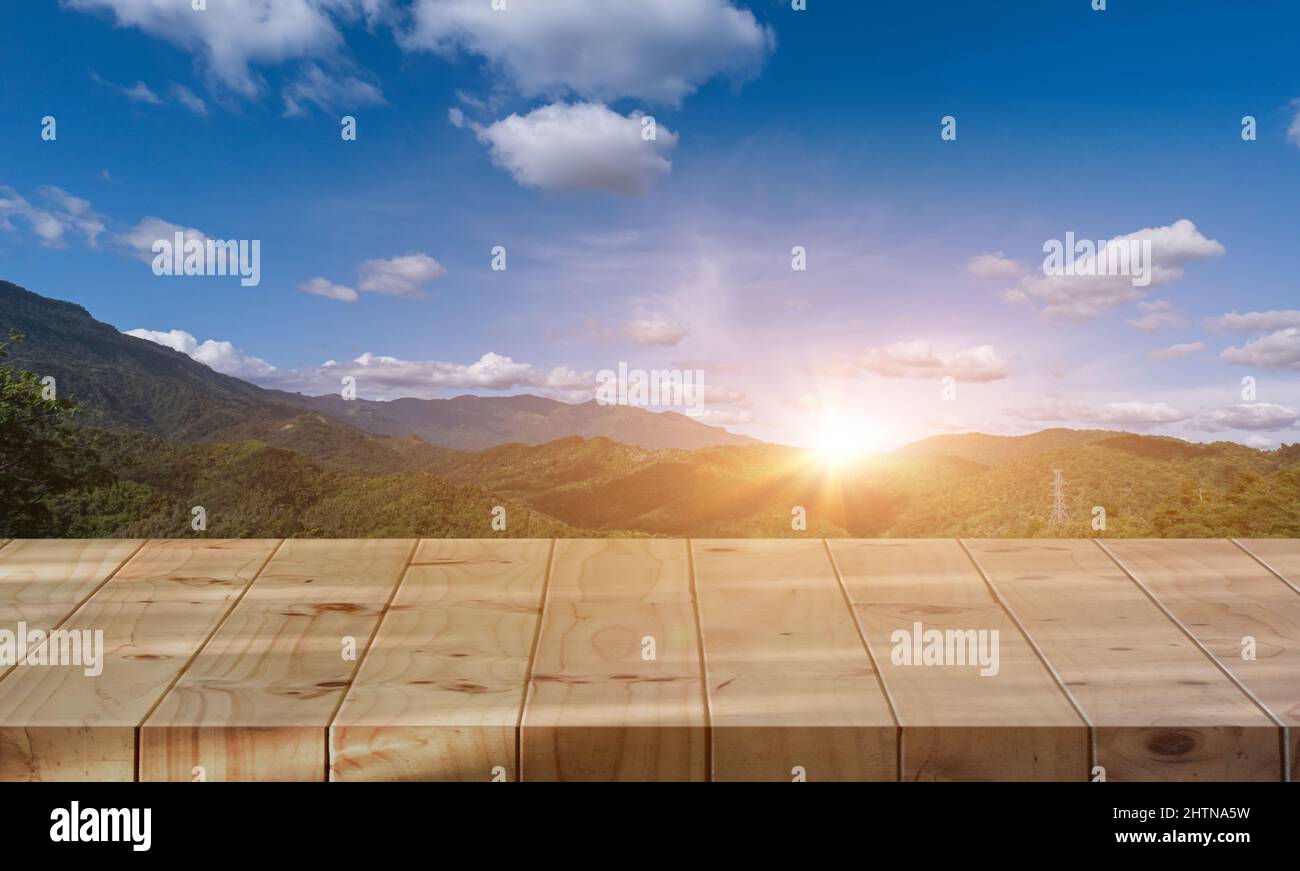empty wooden tabletop with mountain and sunset sky background ...