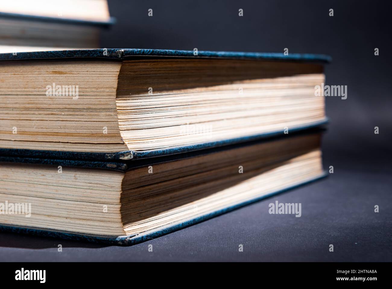 Stack of books with dark background Stock Photo - Alamy
