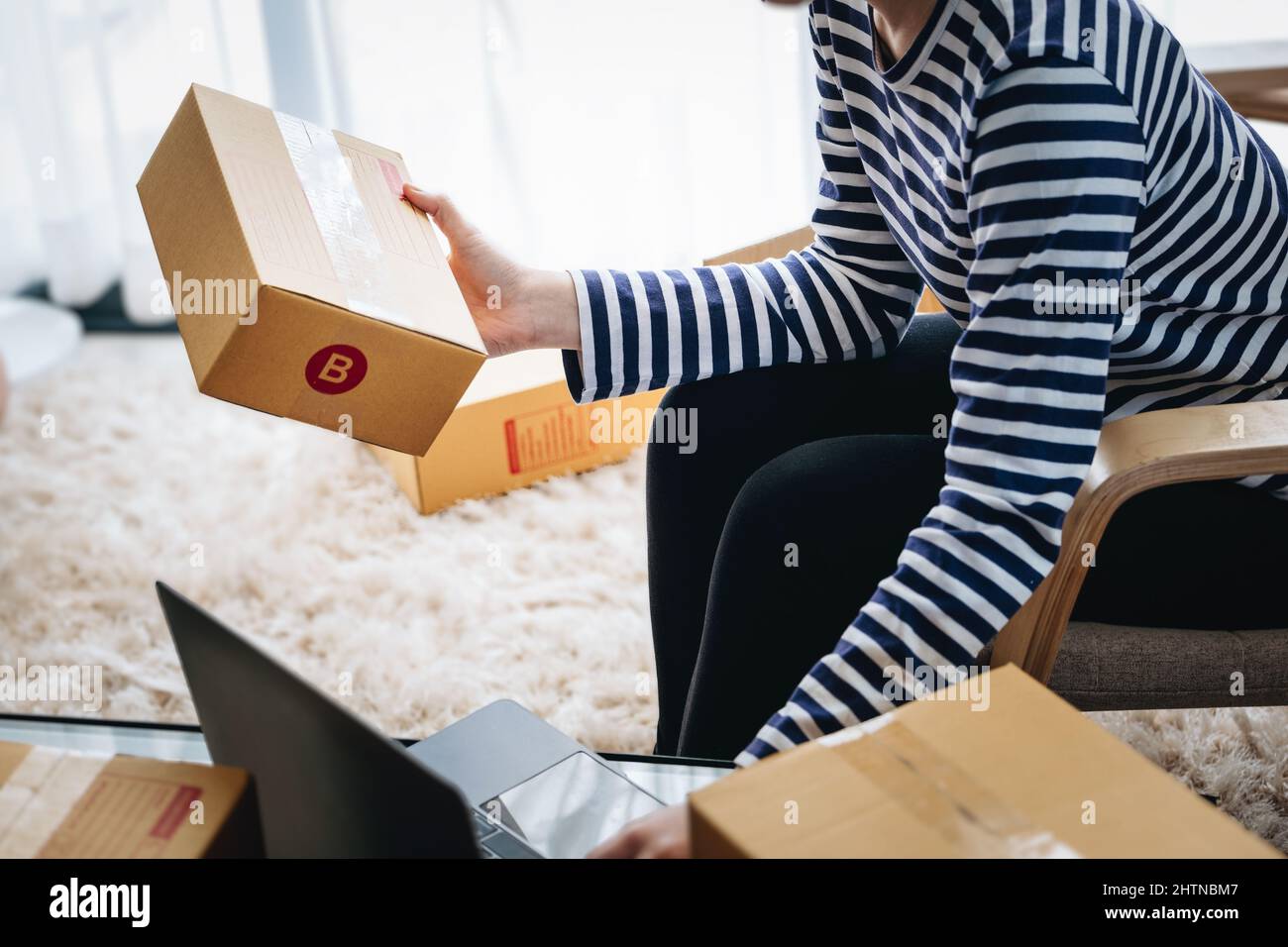 Online merchandising business idea, beautiful girl holding a parcel ...