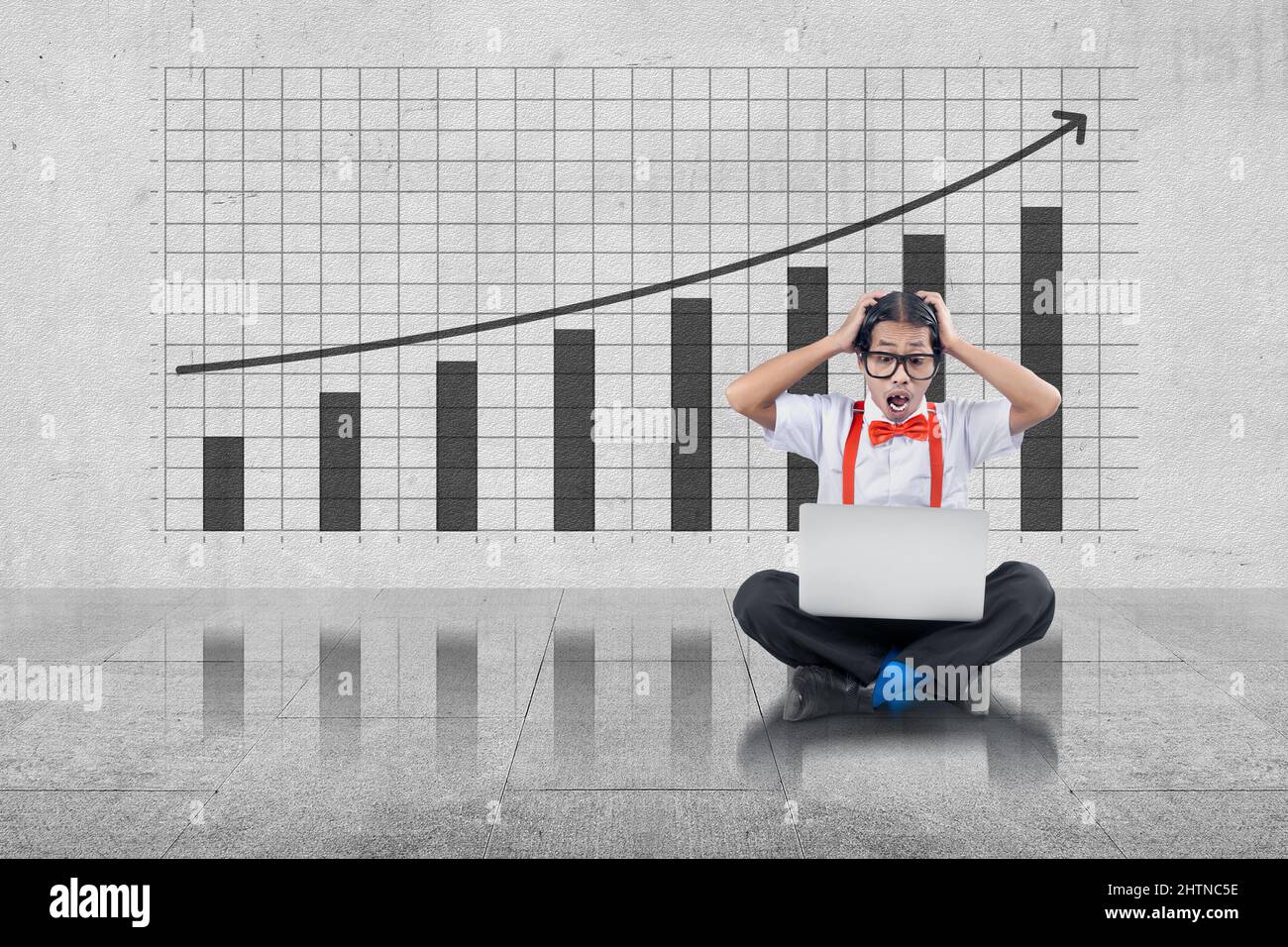 Asian nerd with ugly face sitting while using a laptop with shocked ...