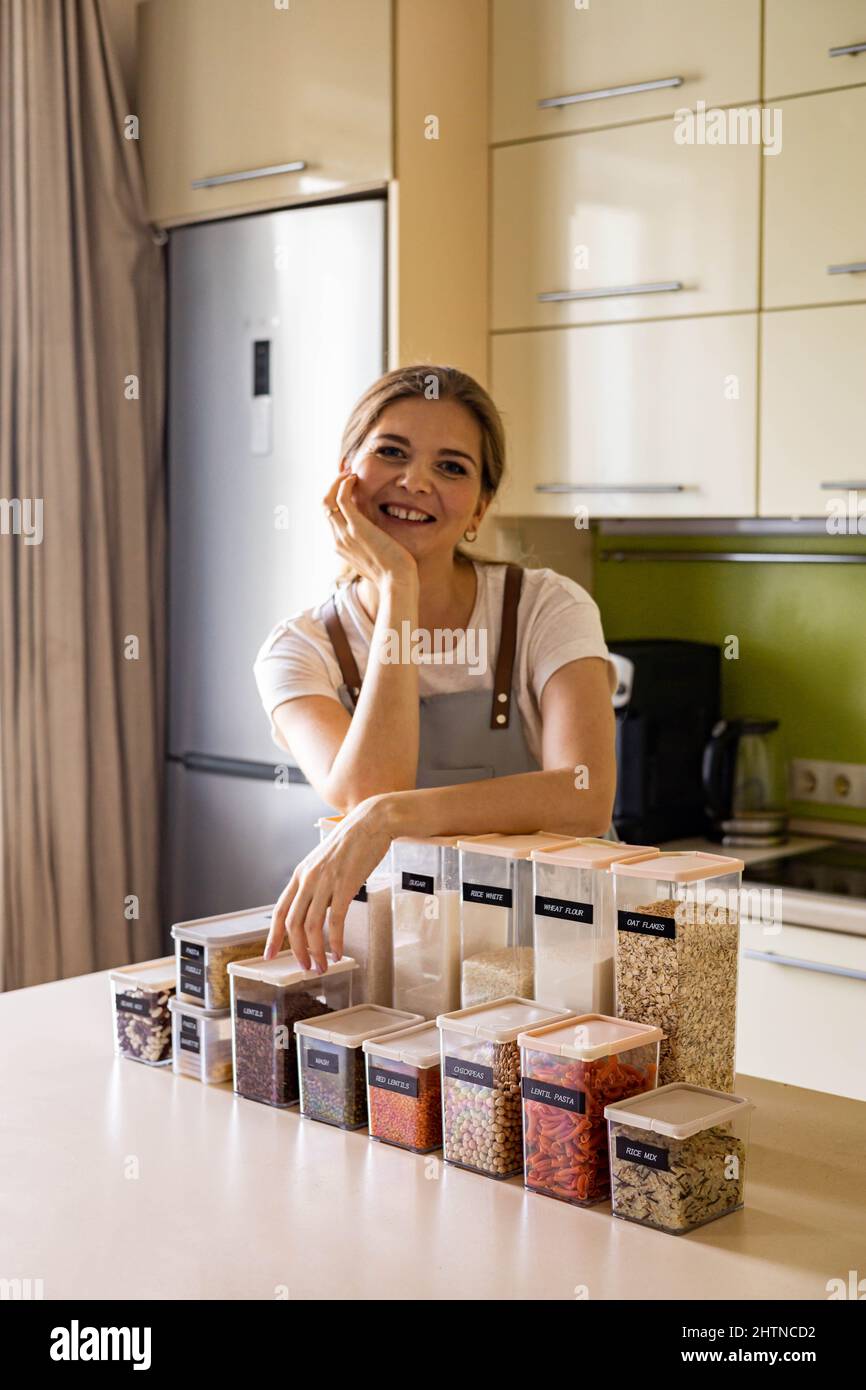 Woman professional space organizer smiling posing with case boxes for ...