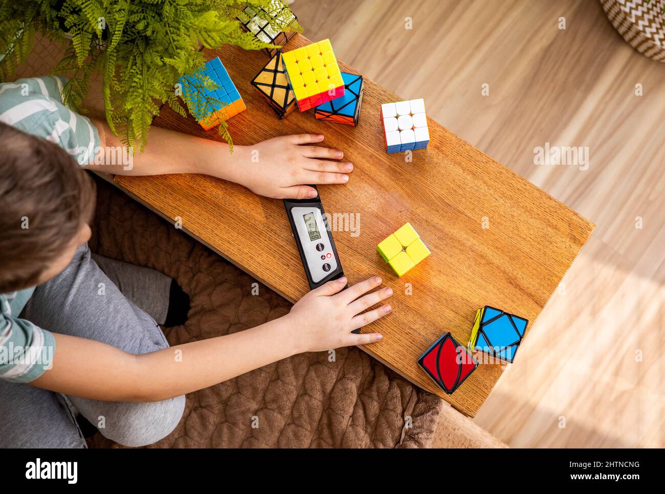 Closeup top view male adolescent hands checking time of assembling ...
