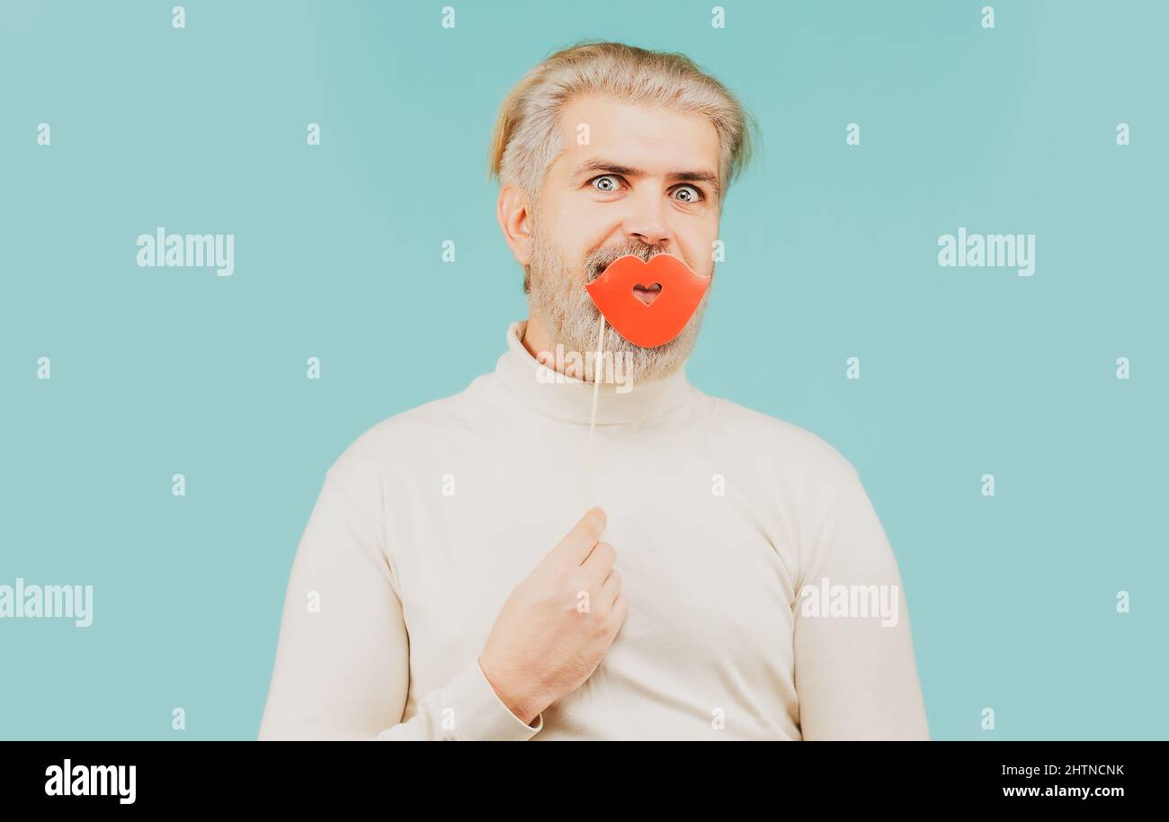 Man with photo booth lips. Man holding party lips on stick. Bearded ...