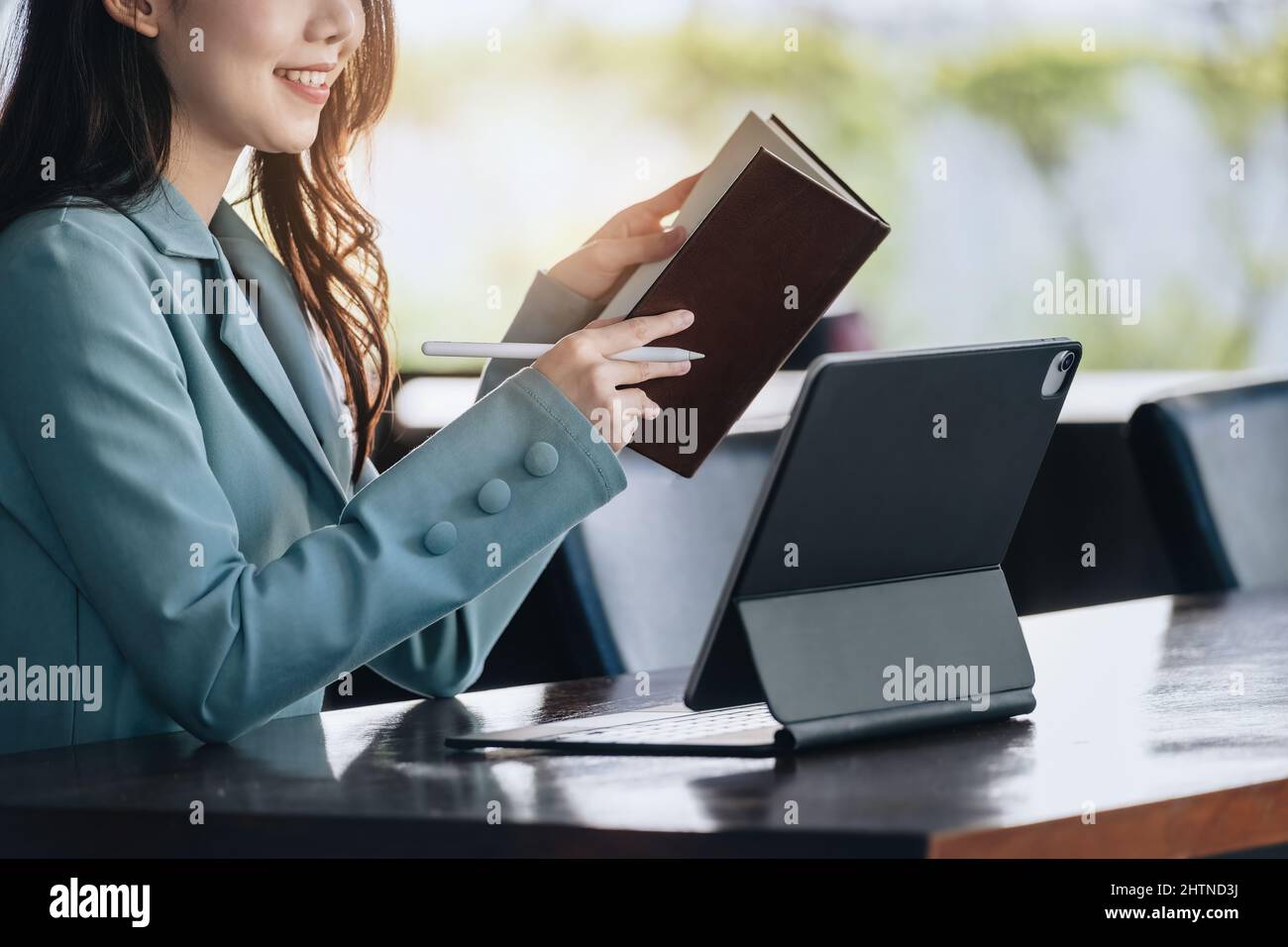 A female entrepreneur or businesswoman showing a smiling face while ...