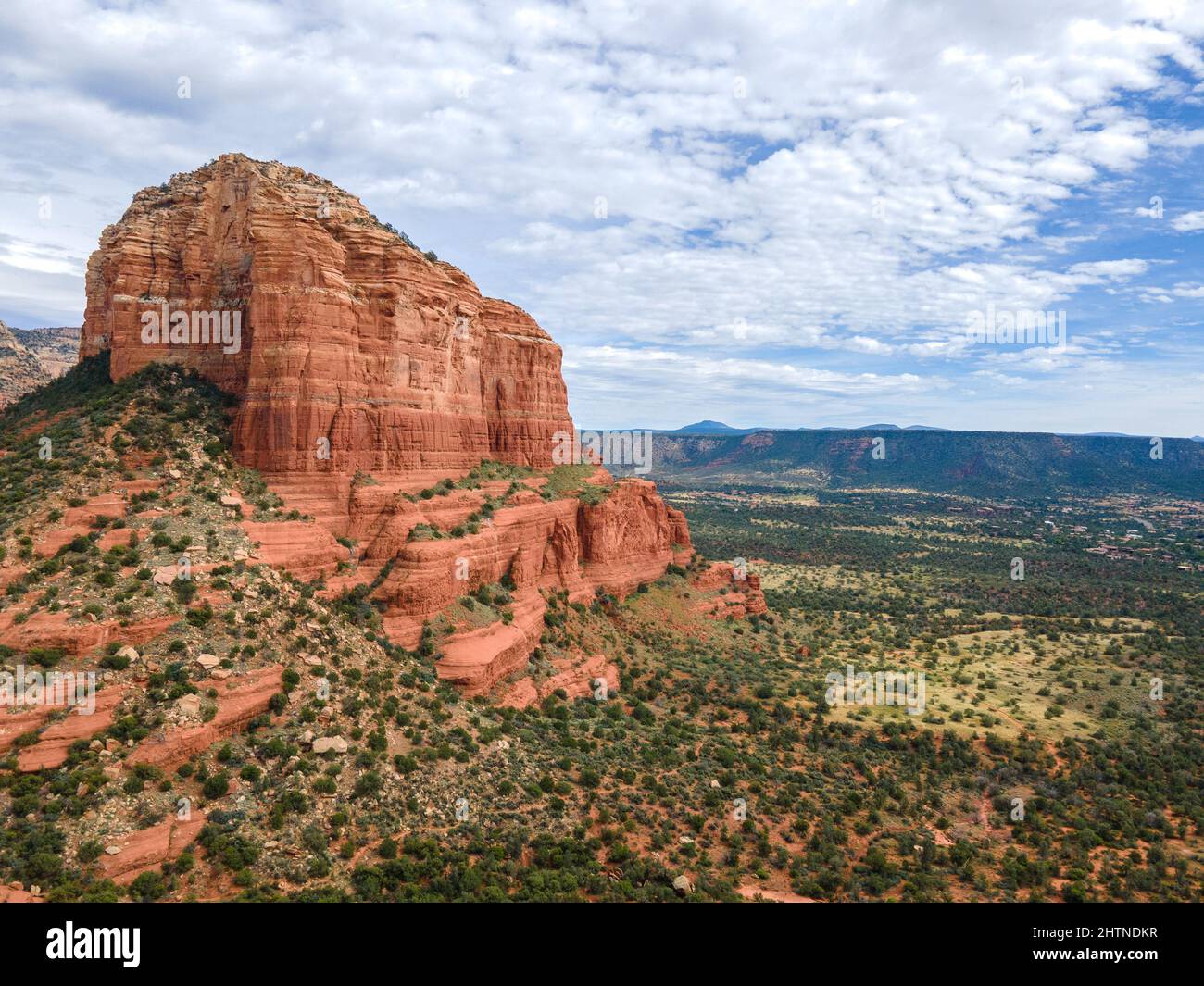 Birds eye view of a huge butte next to a desert valley Stock Photo - Alamy