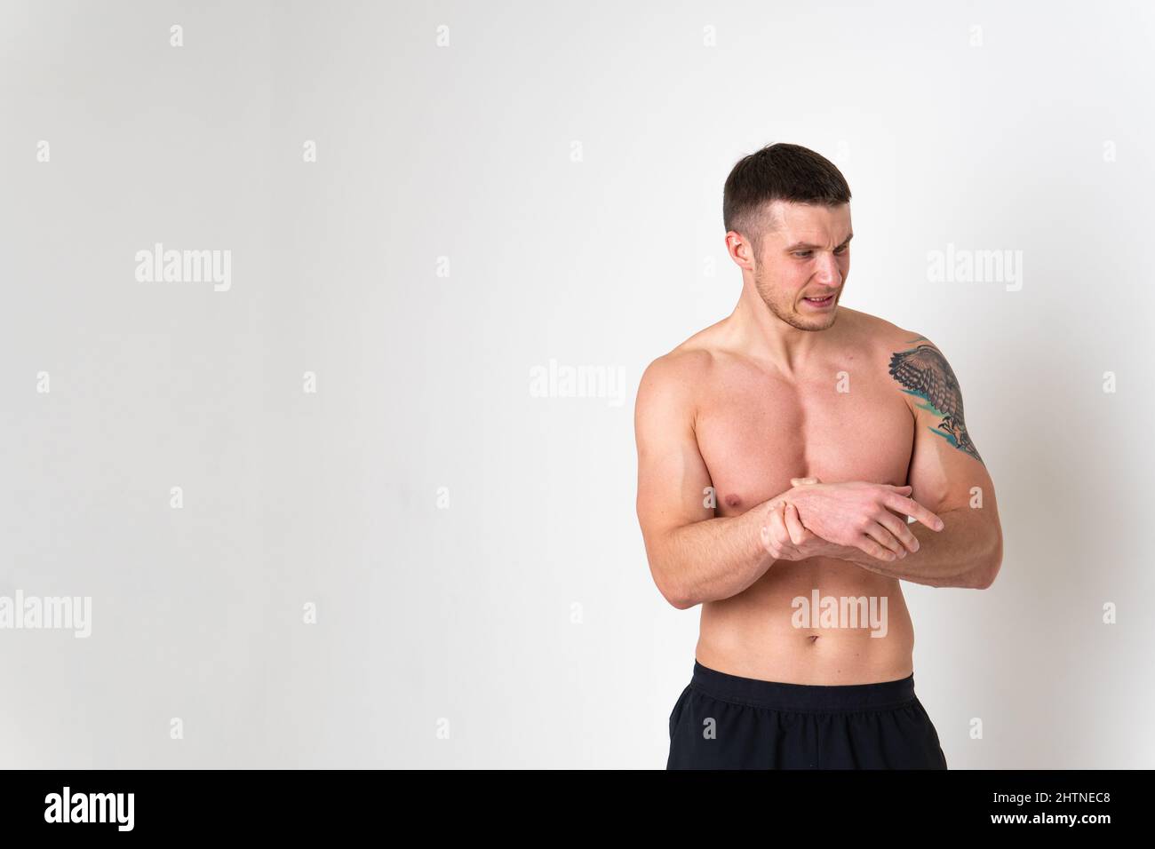 Muscles on the arm ache in a man on a white background sore painful ...