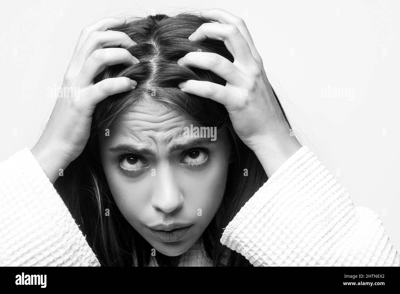 Woman with hair problem. Woman is looking shocked to her lost hair ...