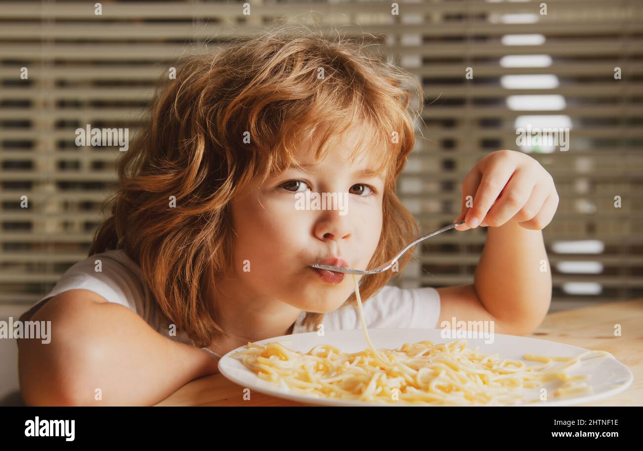 Caucasian child eating pasta, spaghetti. Kids funny face Stock Photo ...