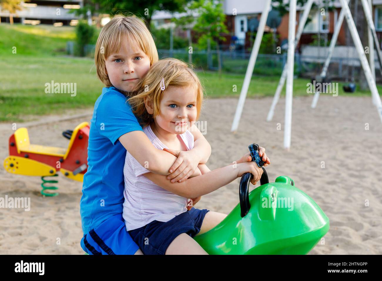 Children in park in summer. Brother hugging little sister. Siblings ...