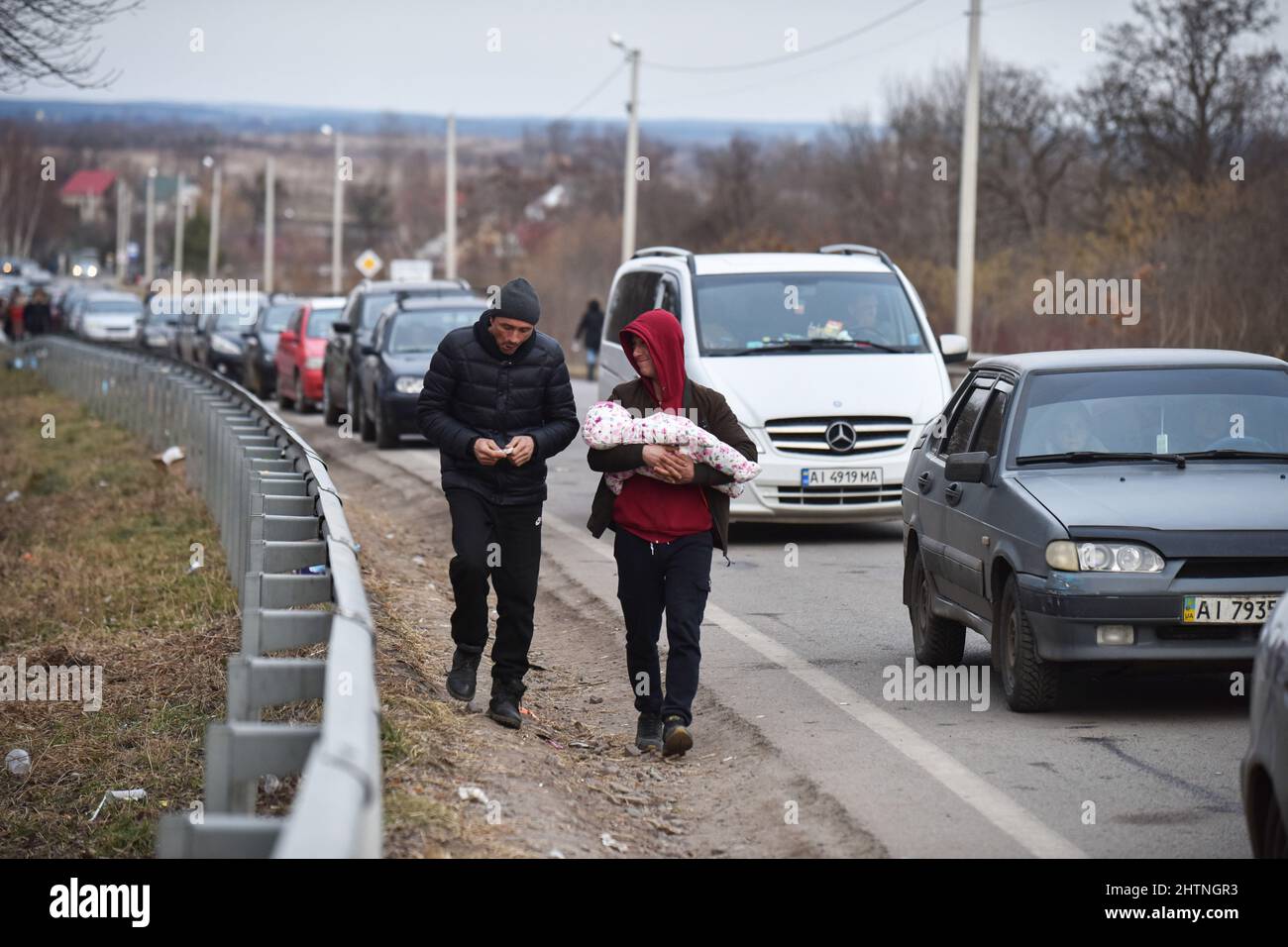 A man with a child in his arms goes to the Shehyni checkpoint to cross ...