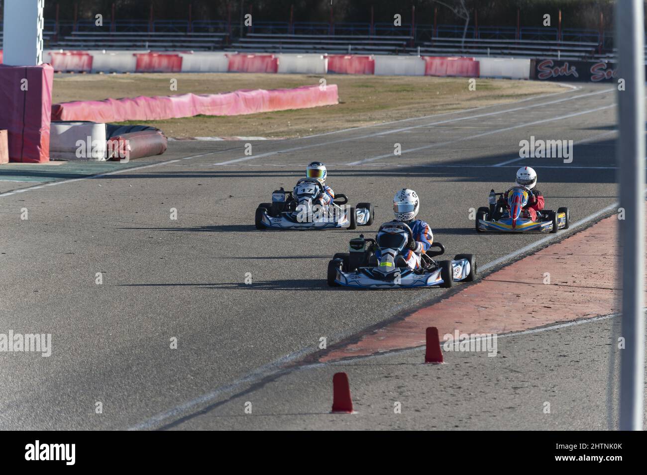 Karting track with men racing go-karts Stock Photo - Alamy