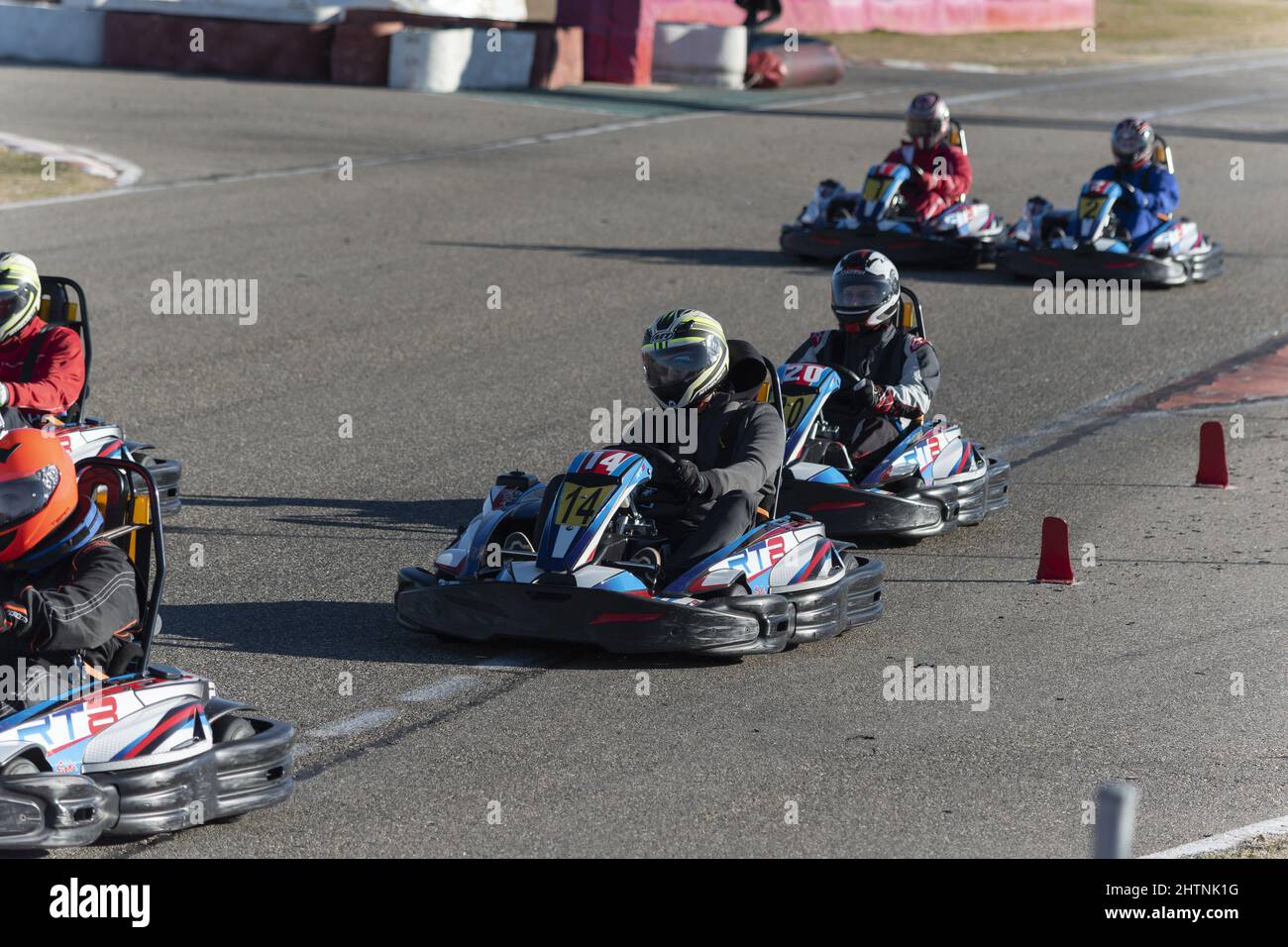 Karting track with men racing go-karts Stock Photo - Alamy