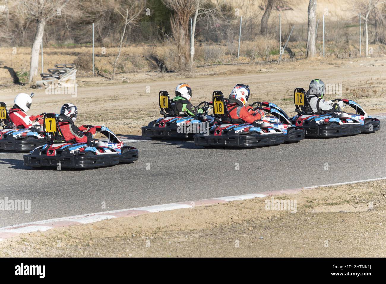 Karting track with men racing go-karts Stock Photo - Alamy