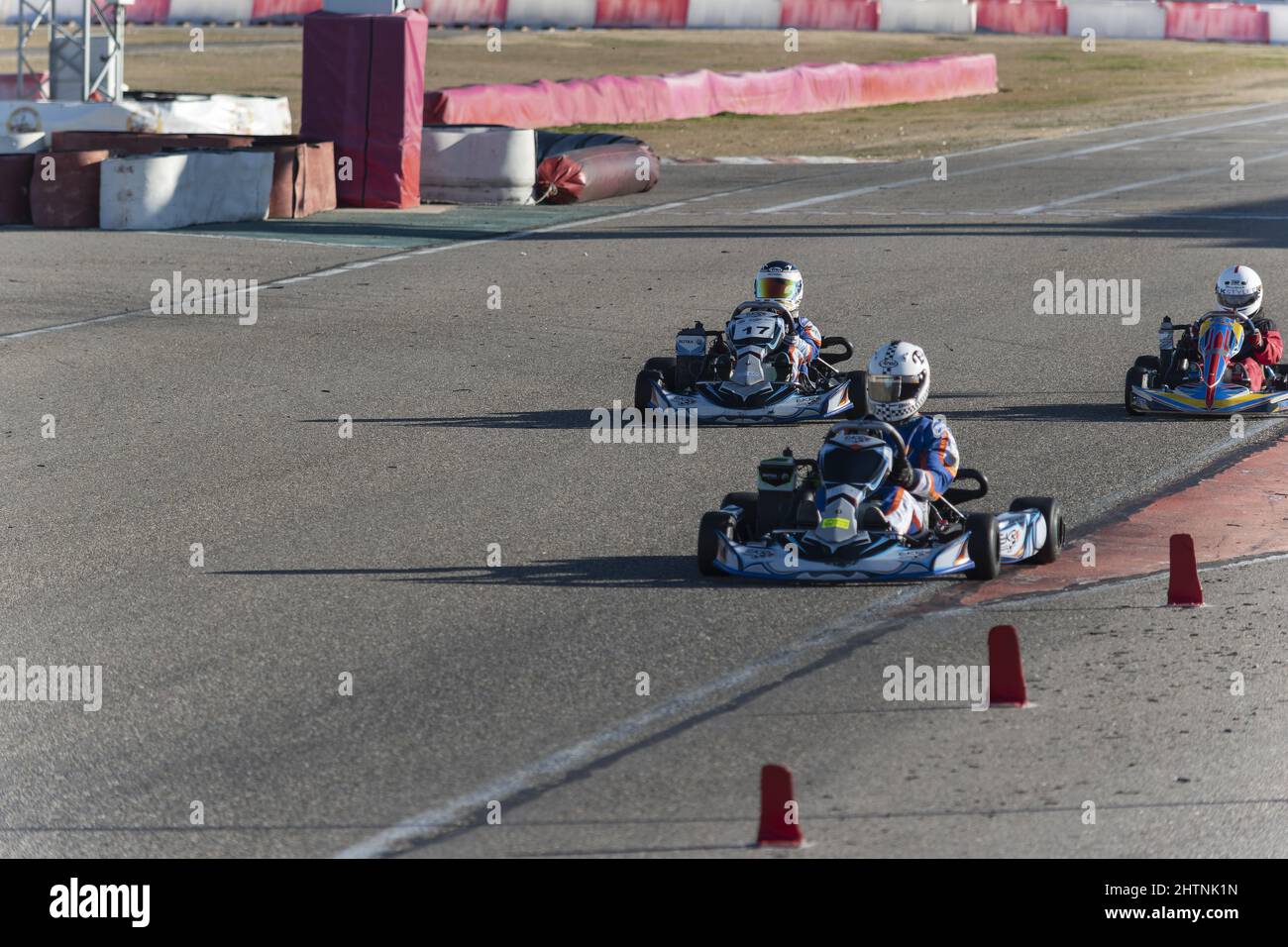 Karting track with men racing go-karts Stock Photo - Alamy