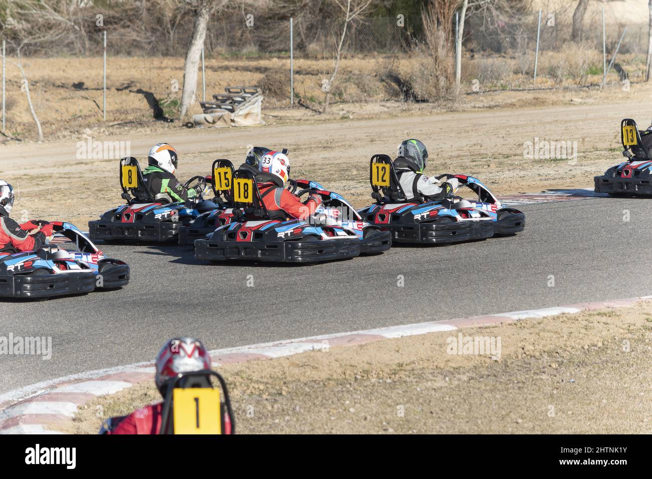 Karting track with men racing go-karts Stock Photo - Alamy