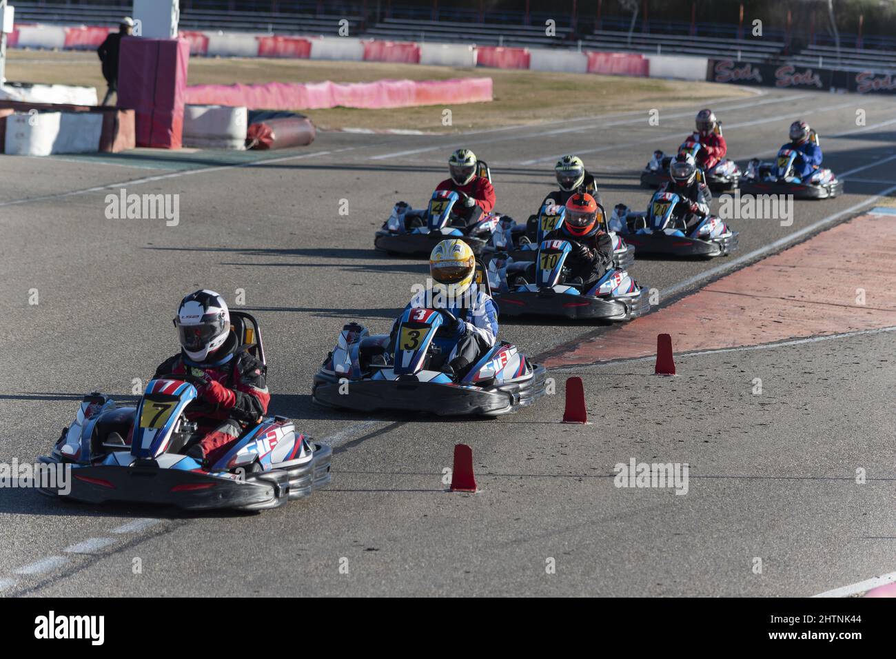 Karting track with men racing go-karts Stock Photo - Alamy