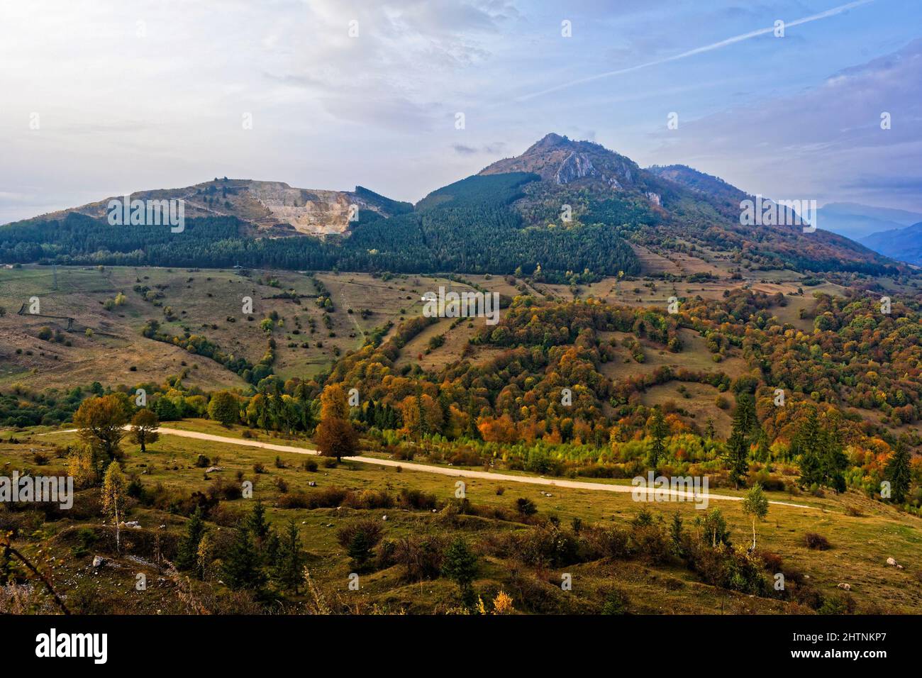 Distant view of the beautiful field with mountains and blue sky on the ...