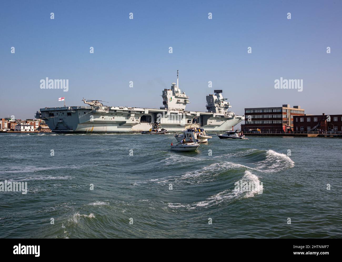 Boats and ship sailing leaving white splash wave behind on a sunny day ...