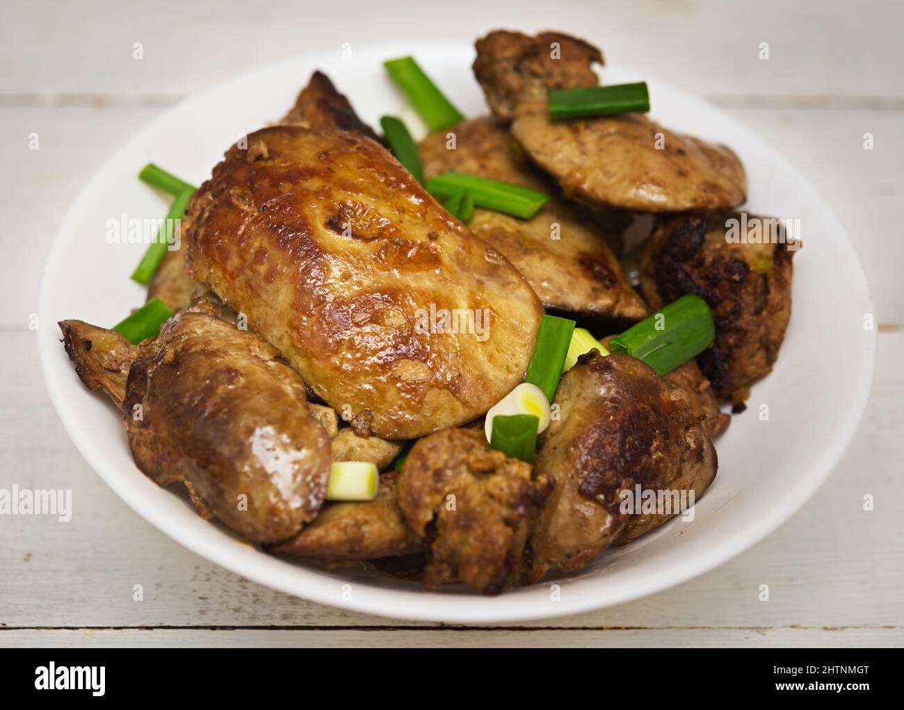 Duck liver with green onion Stock Photo - Alamy