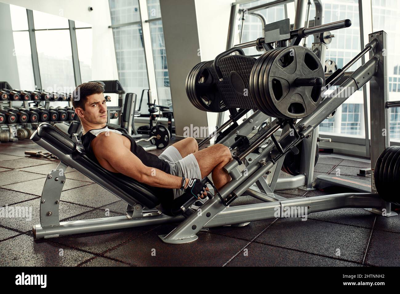 Training legs in the simulator, the athlete works with his legs on the ...