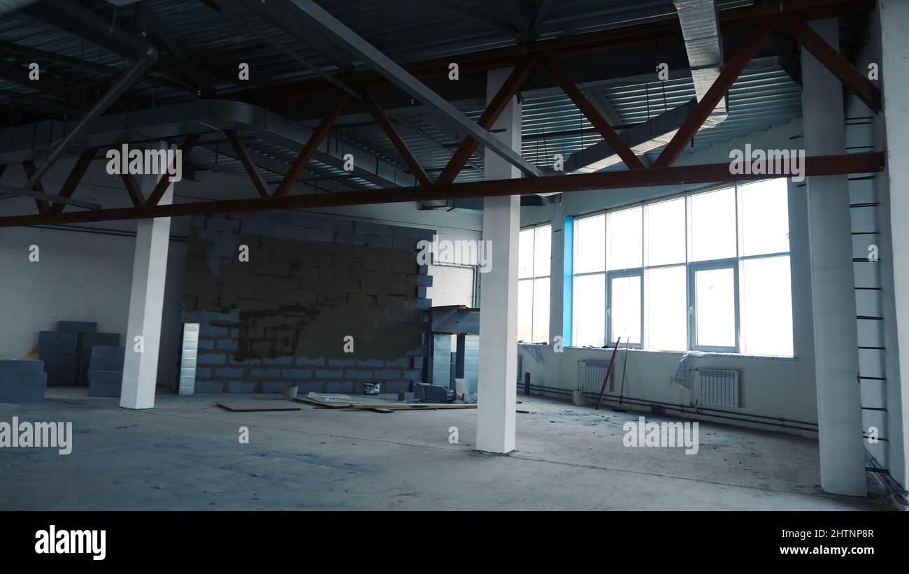 Repair work in empty room with large windows. Stock footage. Renovation ...