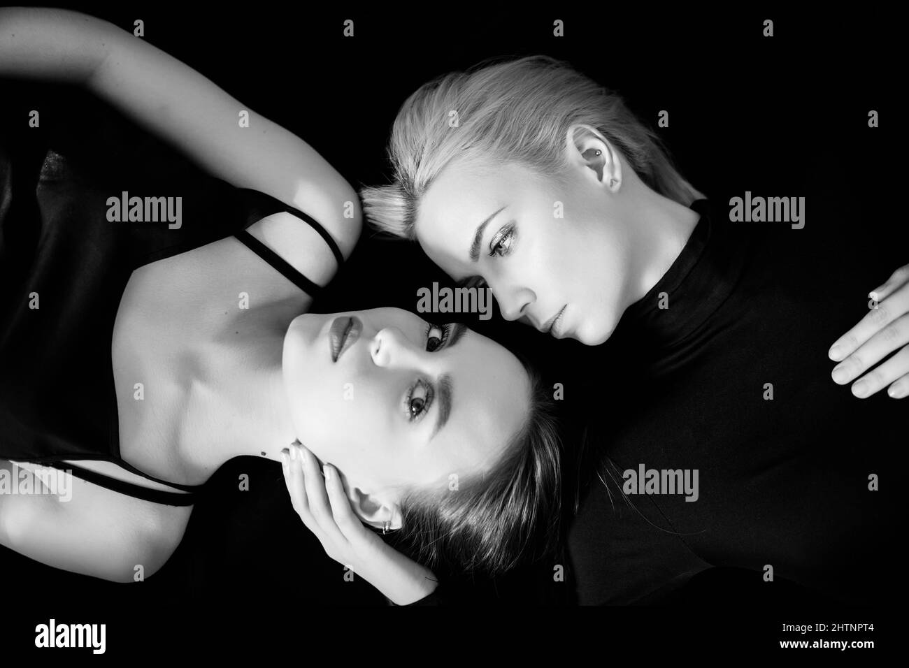 Top view of two young women on dark background Stock Photo - Alamy