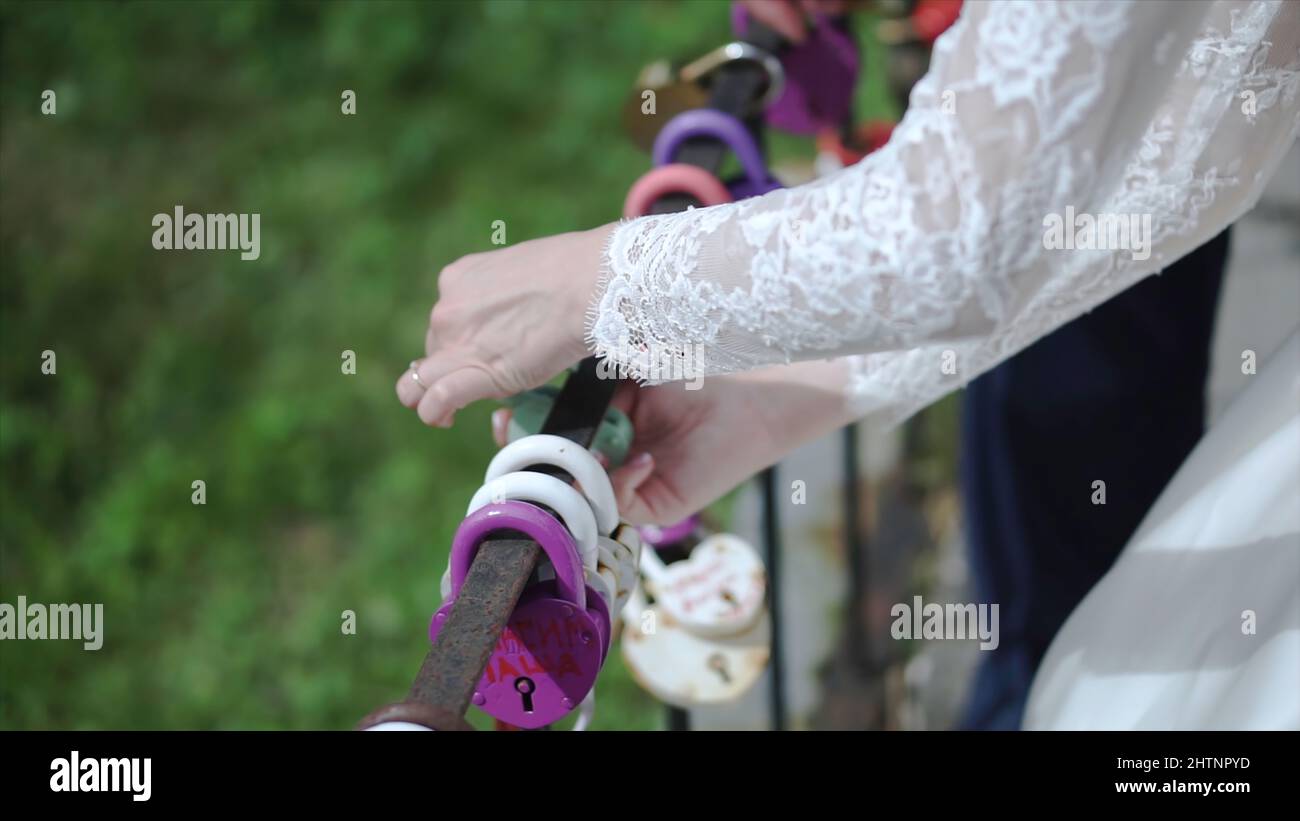 The decorative lock in hands of newlyweds. Clip. Wedding symbol of ...
