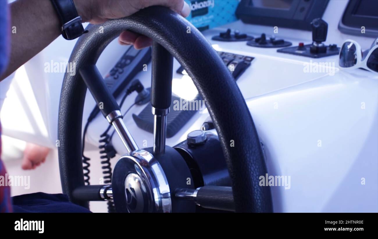 Captain behind the wheel of a luxury yacht. Stock. Closeup of the hands ...