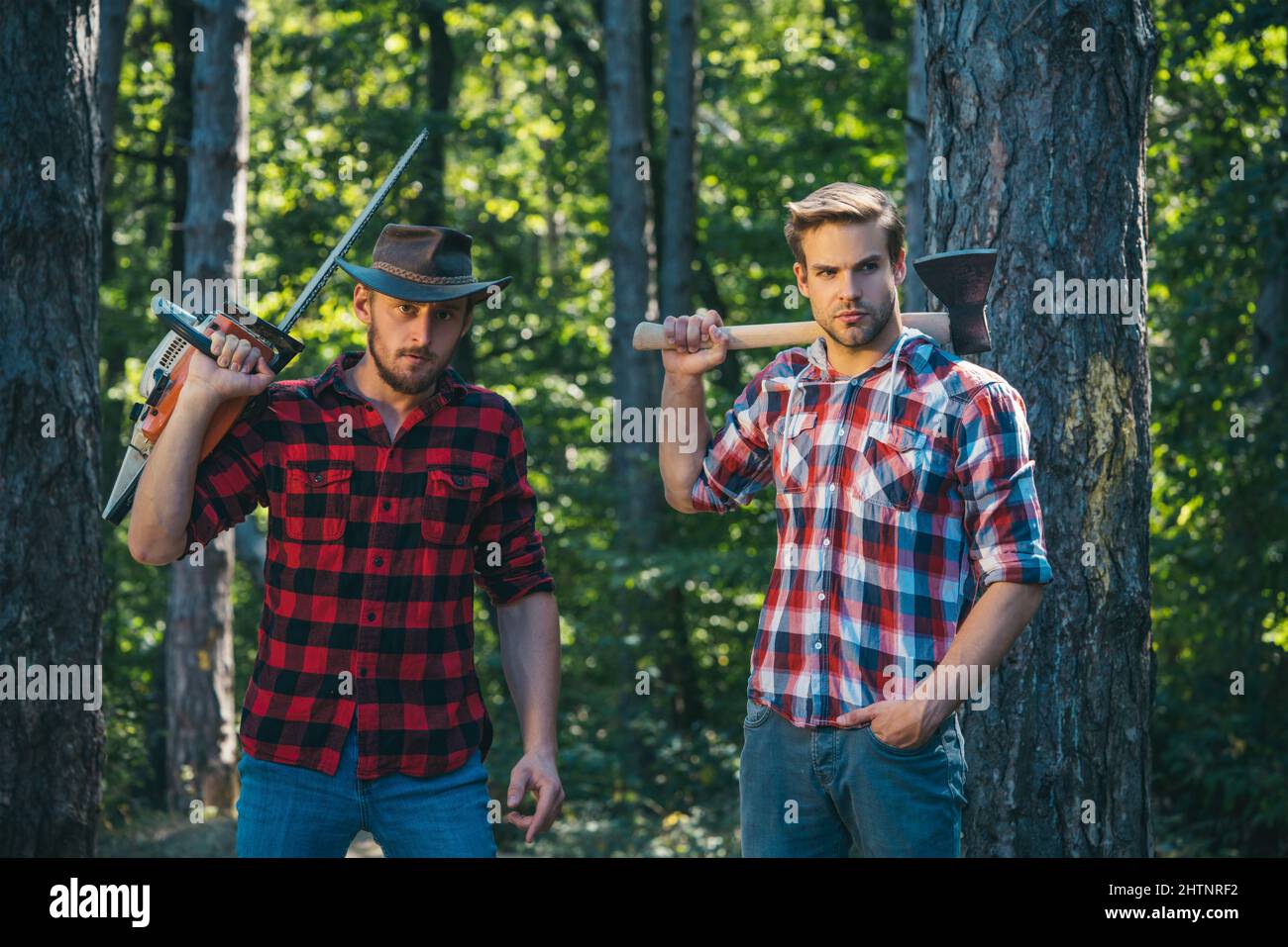 Lumberjack man in red checkered shirt with axe on wooden forest ...