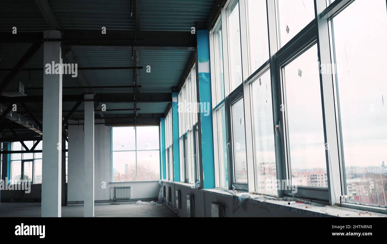 Repair work in empty room with large windows. Stock footage. Renovation ...