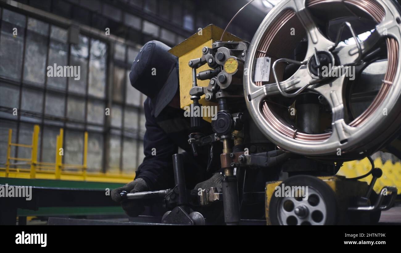 Movement of equipment with wheels at factory. Clip. Engineer checks ...