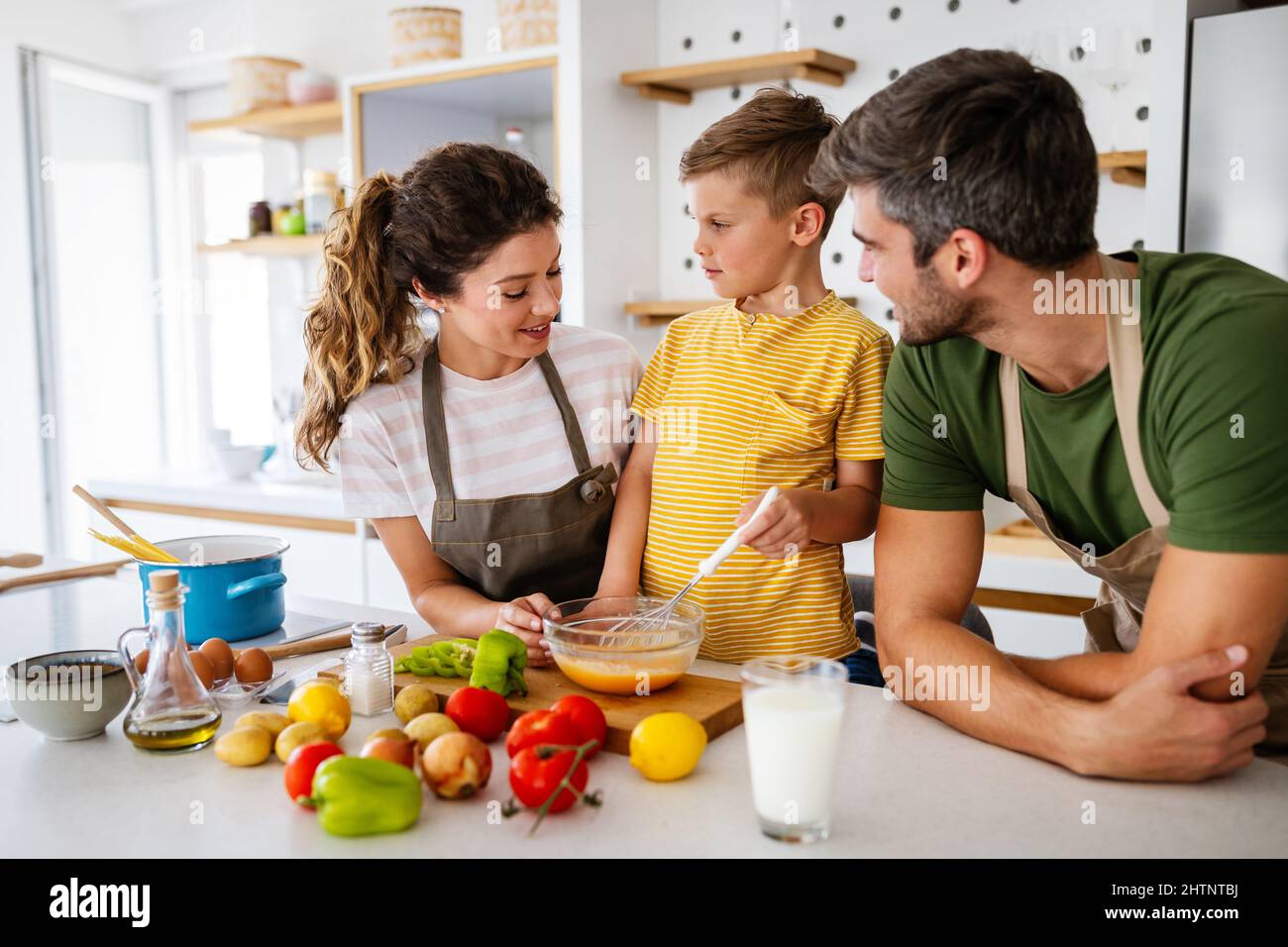 Happy family preparing healthy food together in kitchen Stock Photo - Alamy